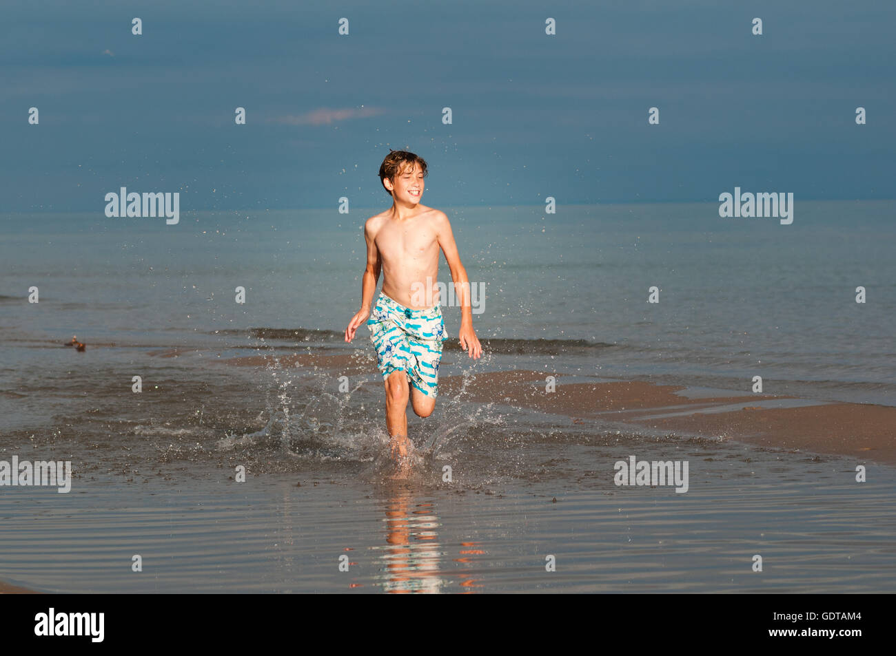 Boy running through water hi-res stock photography and images - Alamy
