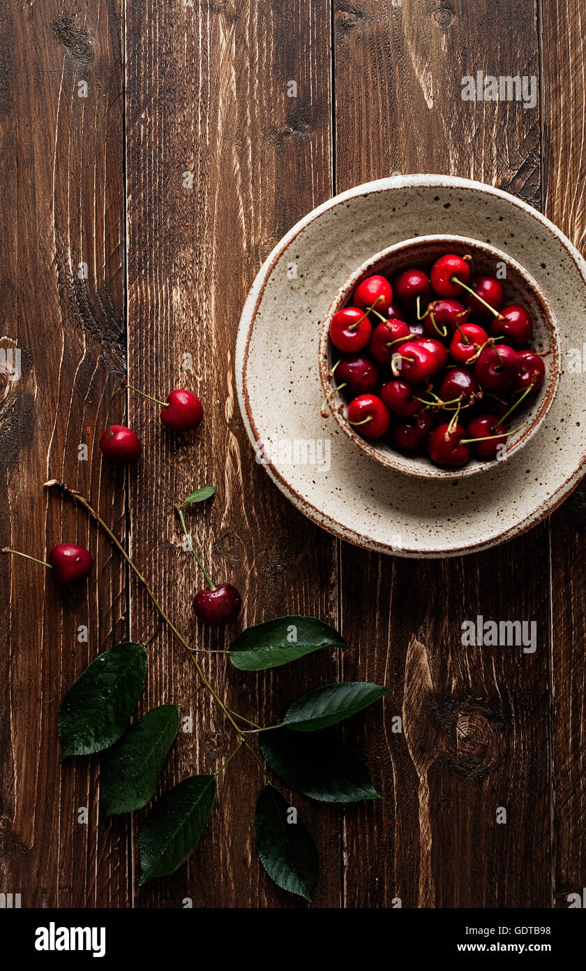 Fresh Cherries on a brown table Stock Photo - Alamy