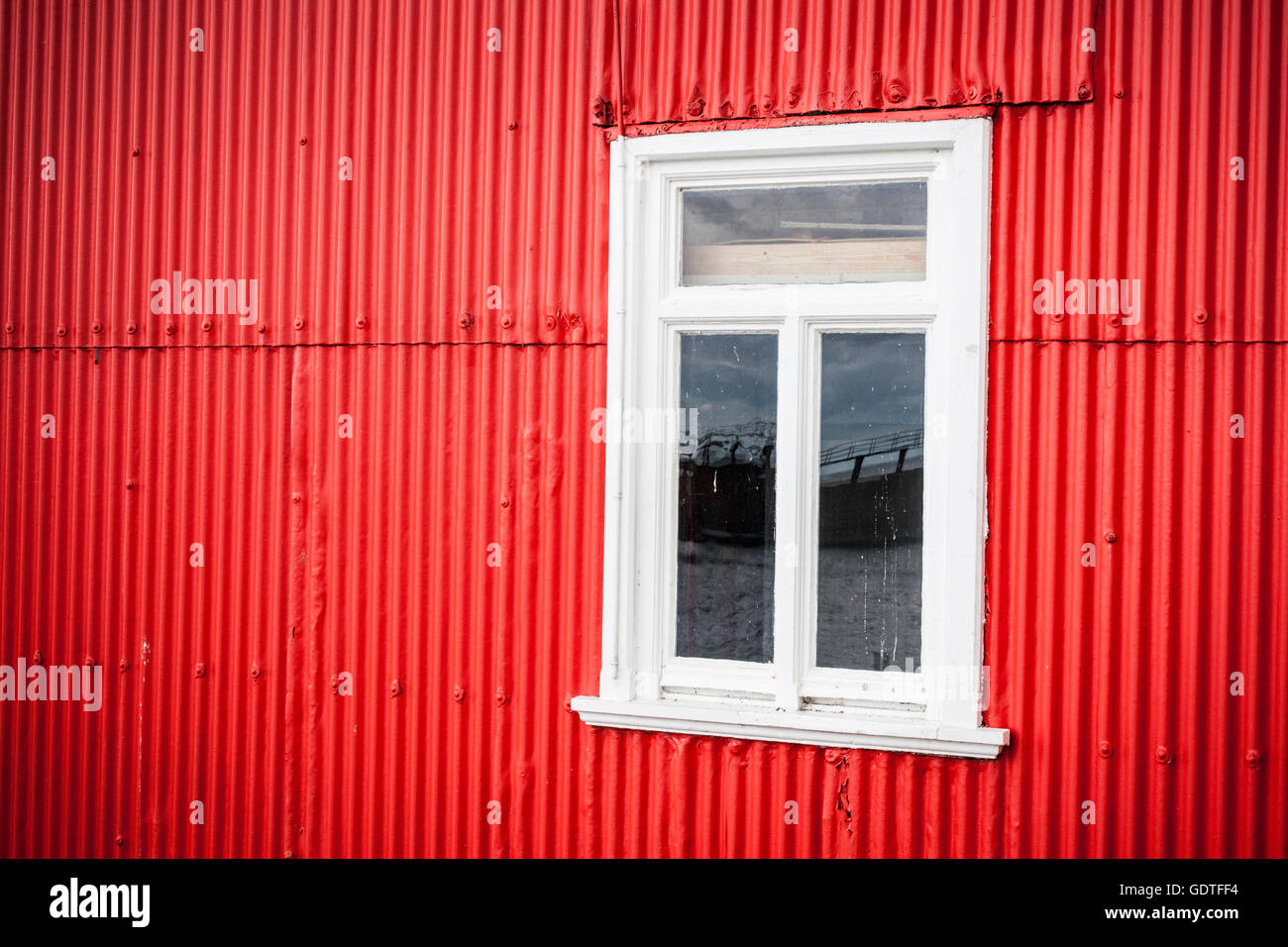Red painted corrugated iron hut with a white window overlooking Blyth ...