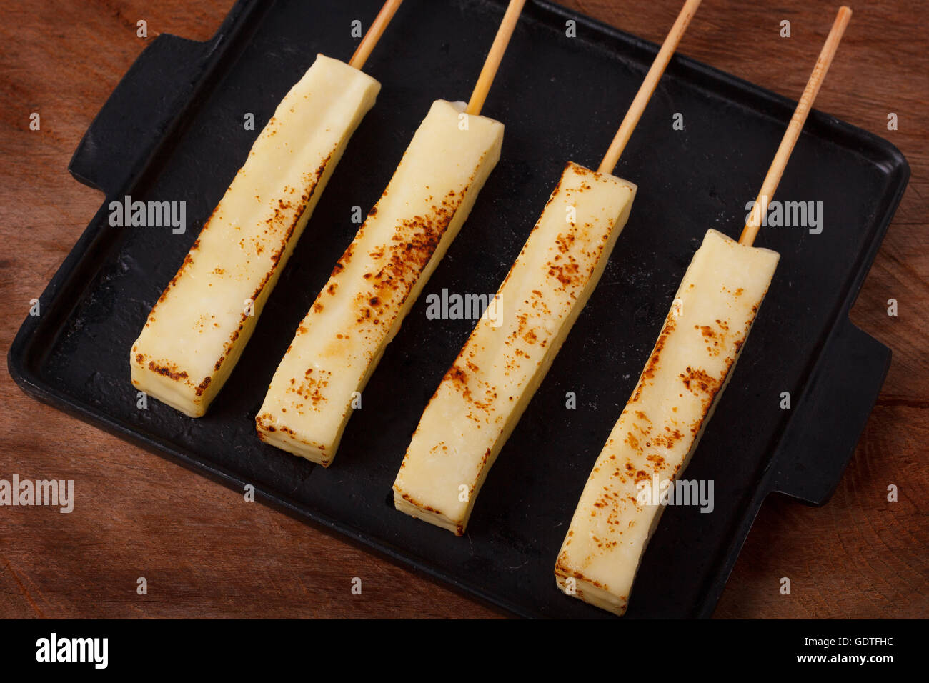 Brazilian traditional cheese queijo coalho on pan on wooden background ...