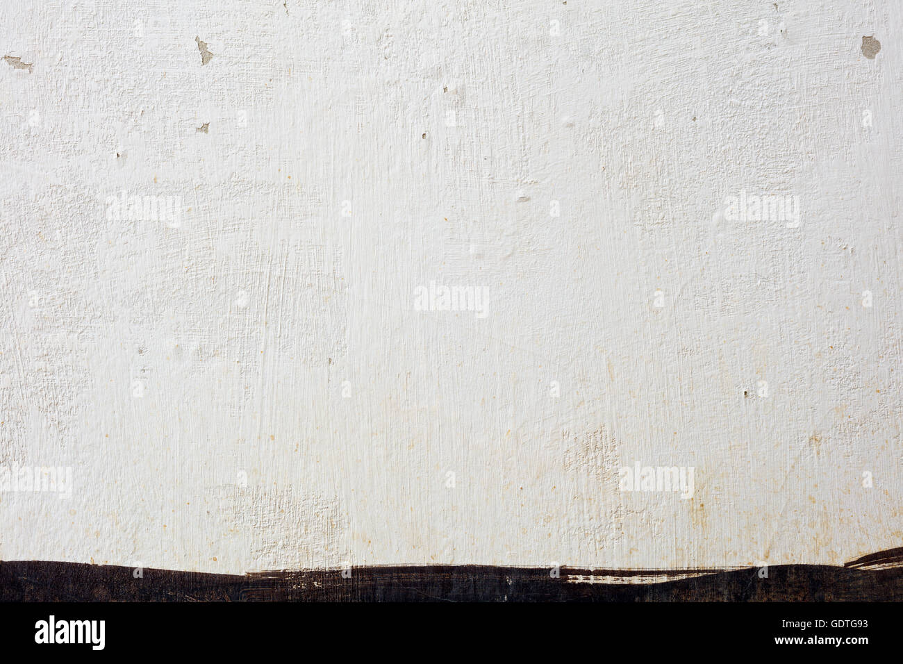 White wall plastered with bitumen coating below as a architecture ...