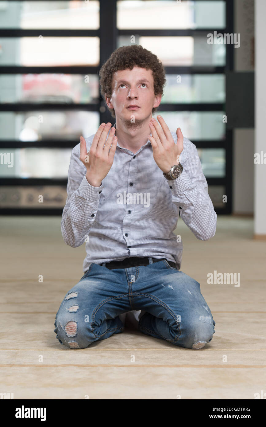 Humble White Muslim Man Is Praying In The Mosque - Afro Lock Hair Curly ...