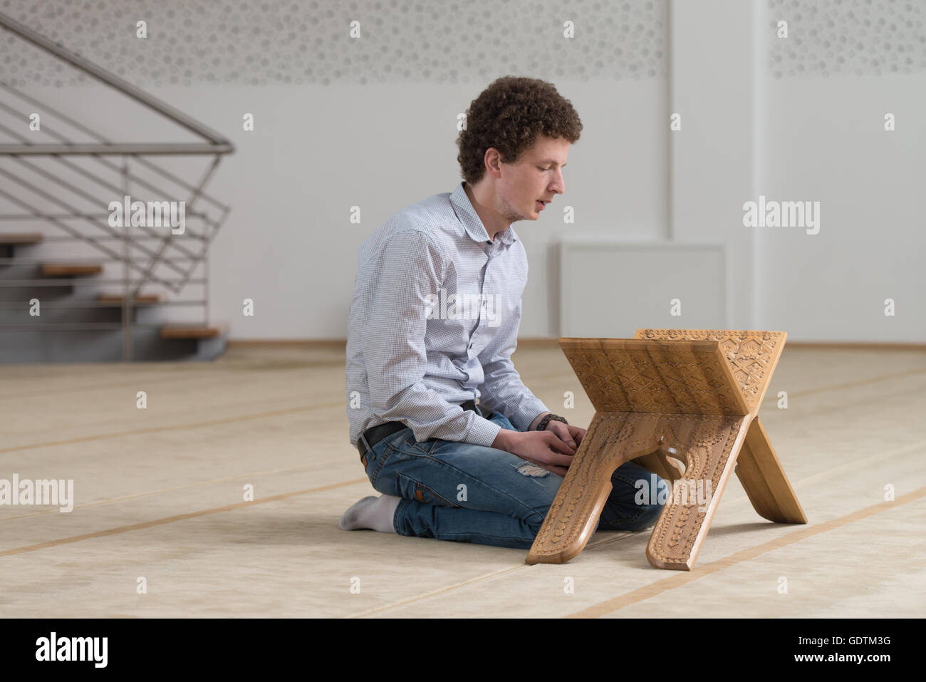 White Muslim Man Is Reading The Koran In The Mosque - Afro Lock Hair ...