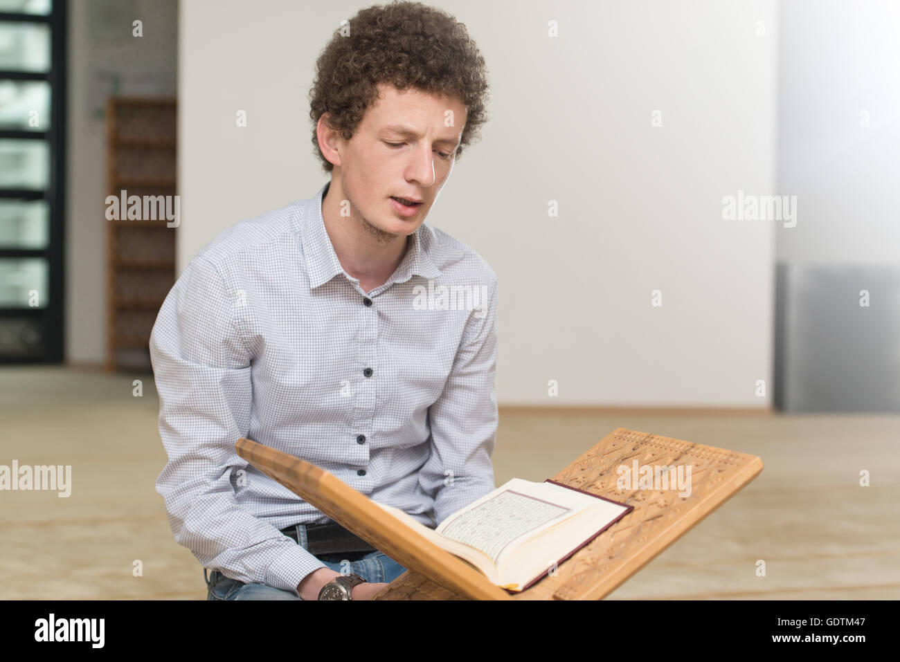 White Muslim Man Is Reading The Koran In The Mosque - Afro Lock Hair ...