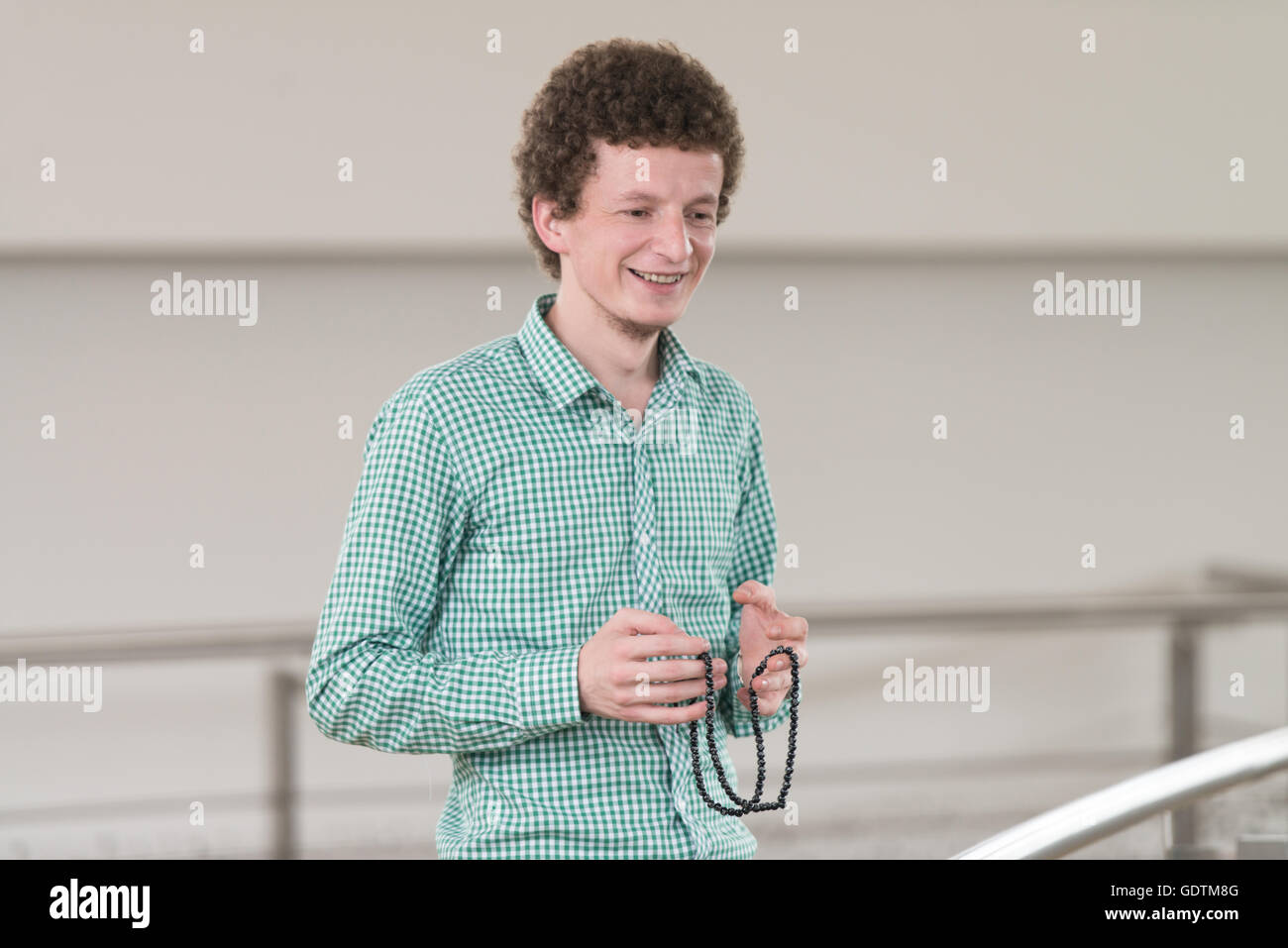 Portrait Of A White Muslim Man With Afro Lock Hair Curly Is Praying In ...