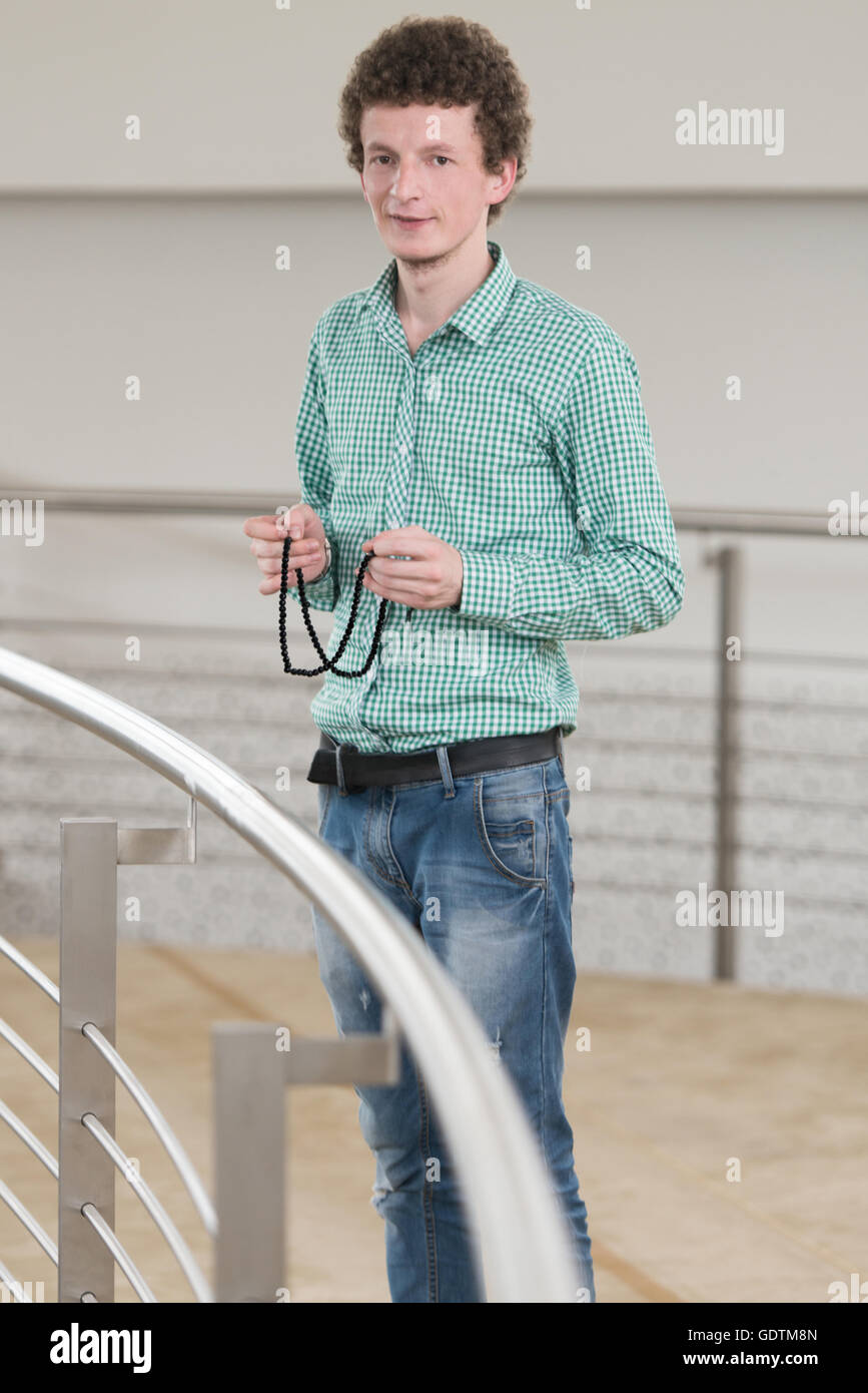 Portrait Of A White Muslim Man With Afro Lock Hair Curly Is Praying In ...