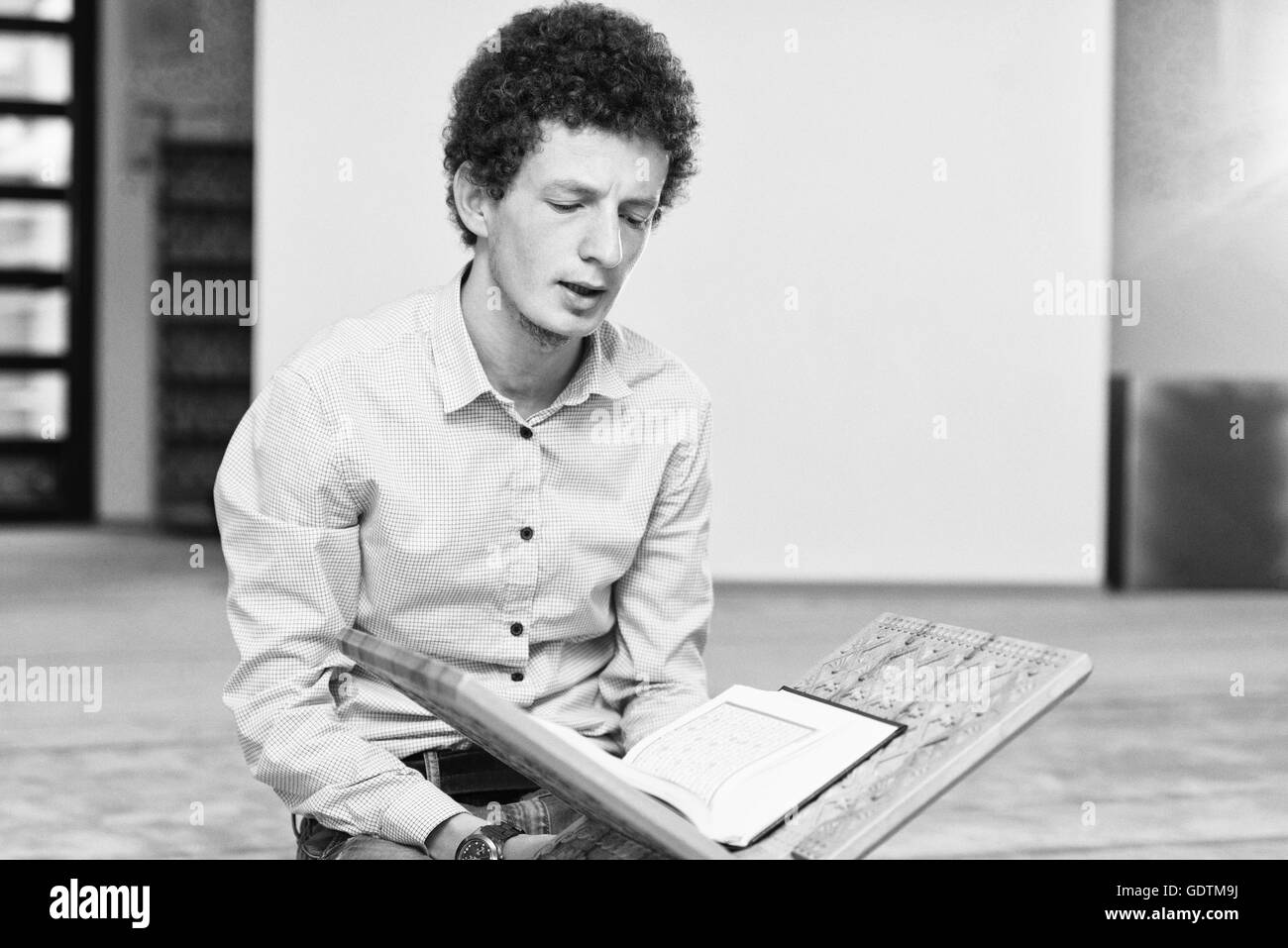 White Muslim Man Is Reading The Koran In The Mosque - Afro Lock Hair ...