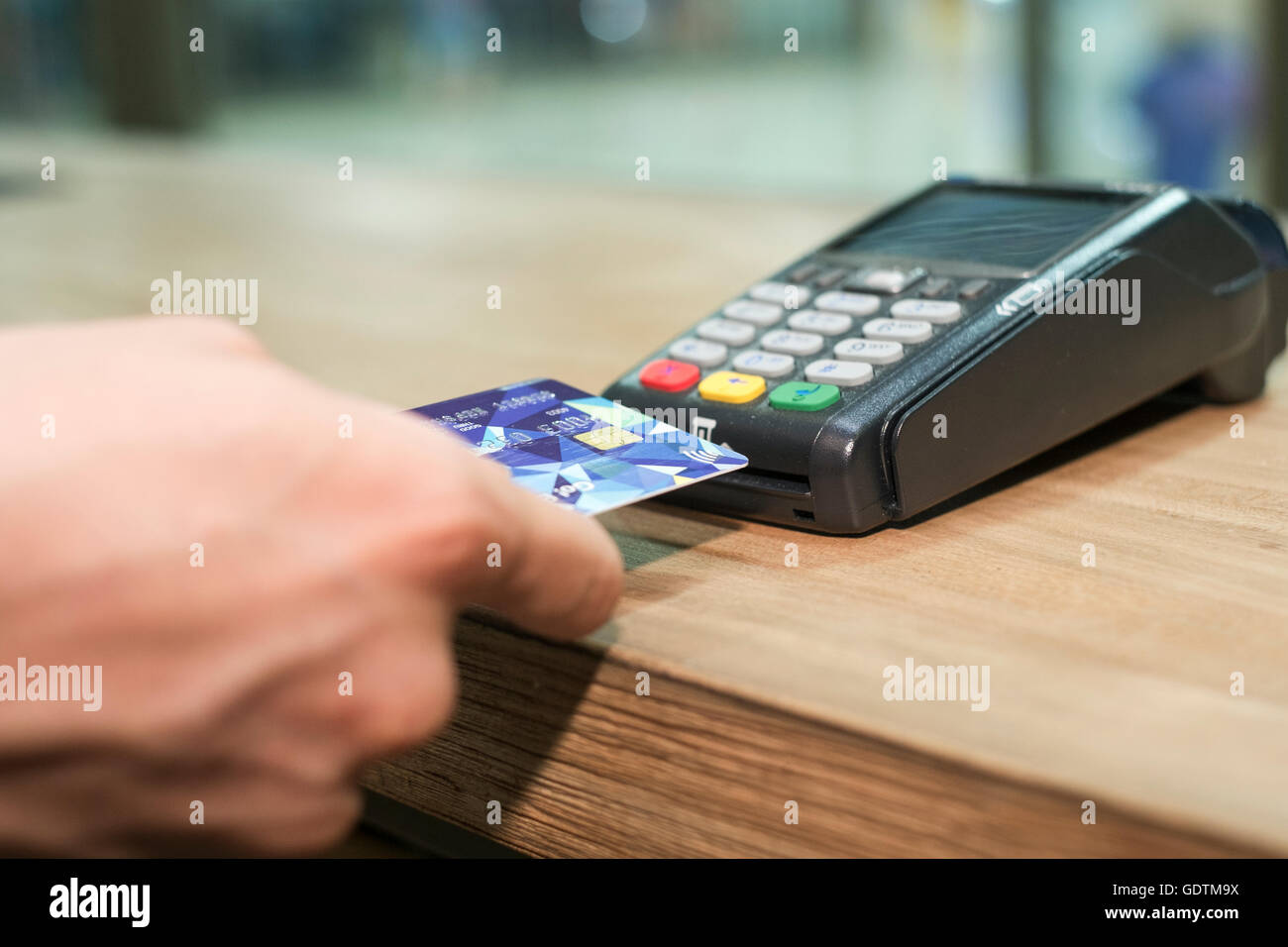 Man's hands carry out payment according to the card by means of the ...