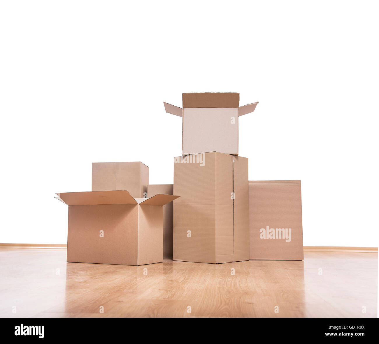 Empty room with a white wall and moving boxes on the floor Stock Photo ...