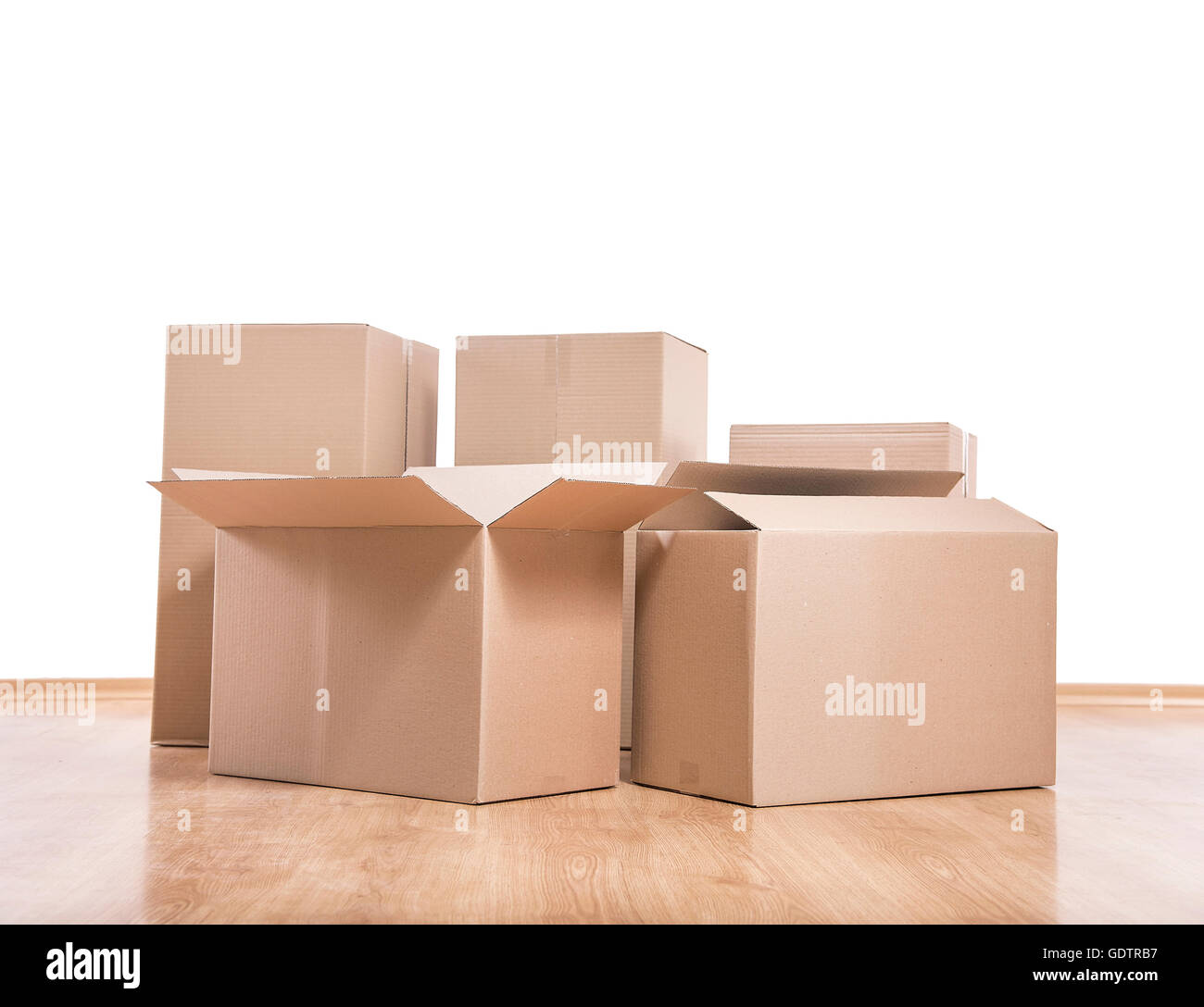 Empty room with a white wall and moving boxes on the floor Stock Photo ...