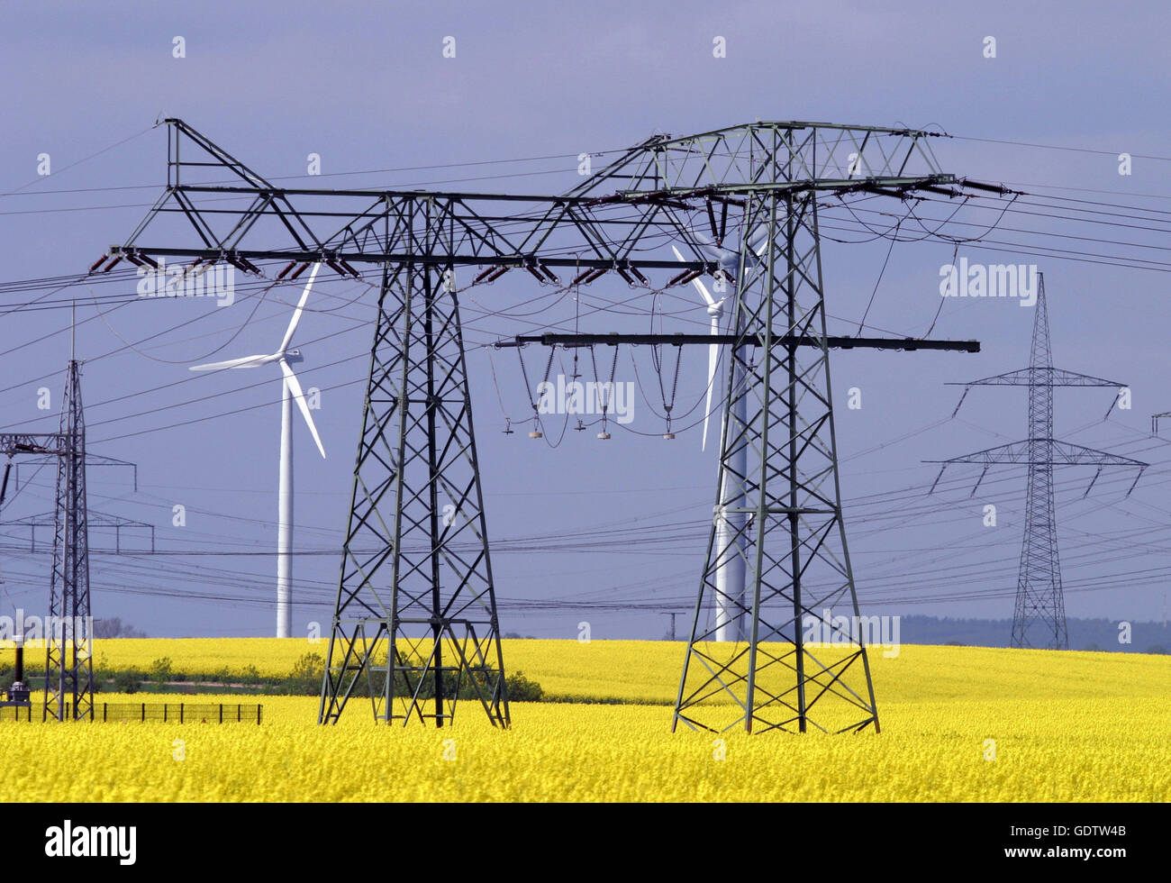 Electricity pylons and wind turbines Stock Photo - Alamy