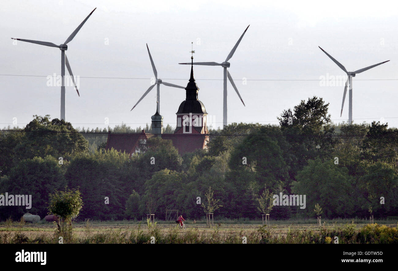 Wind turbines behind a church Stock Photo - Alamy