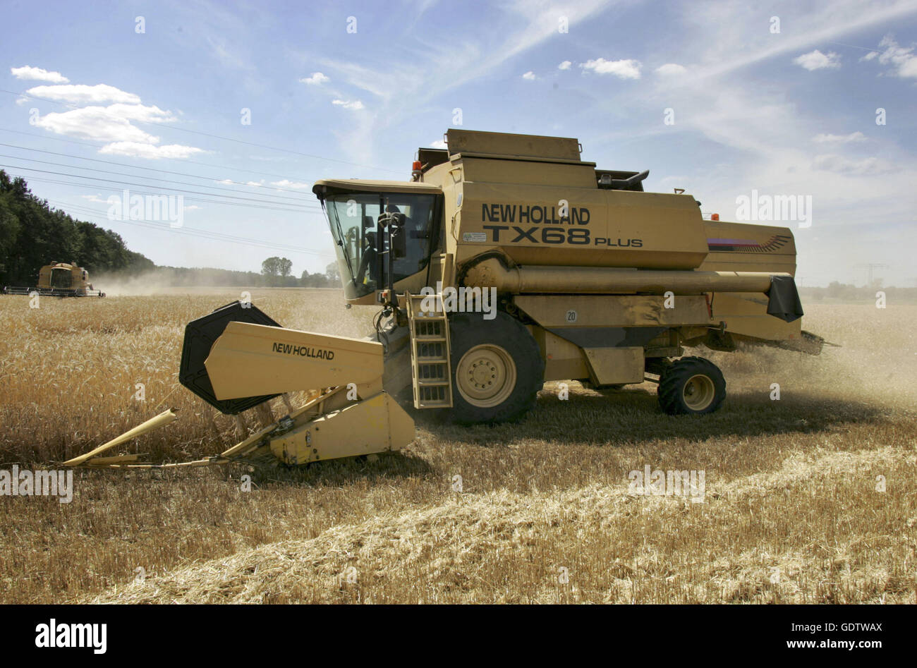 Combine harvester during barley harvest Stock Photo - Alamy