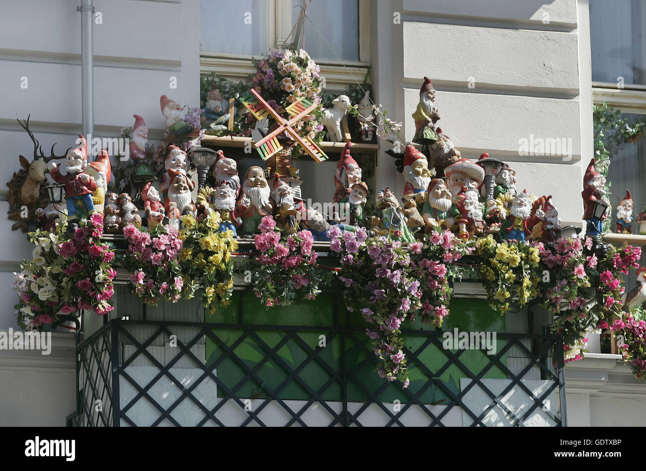 Garden gnomes in different sizes are placed on a balcony hi-res stock ...