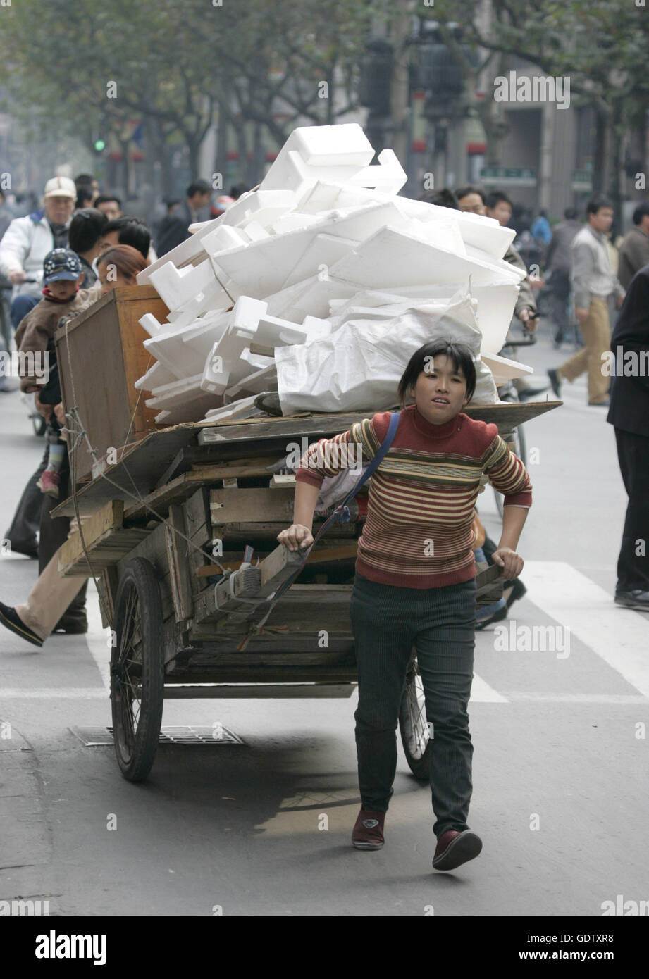 Woman pulling a handcart in Shanghai Stock Photo - Alamy
