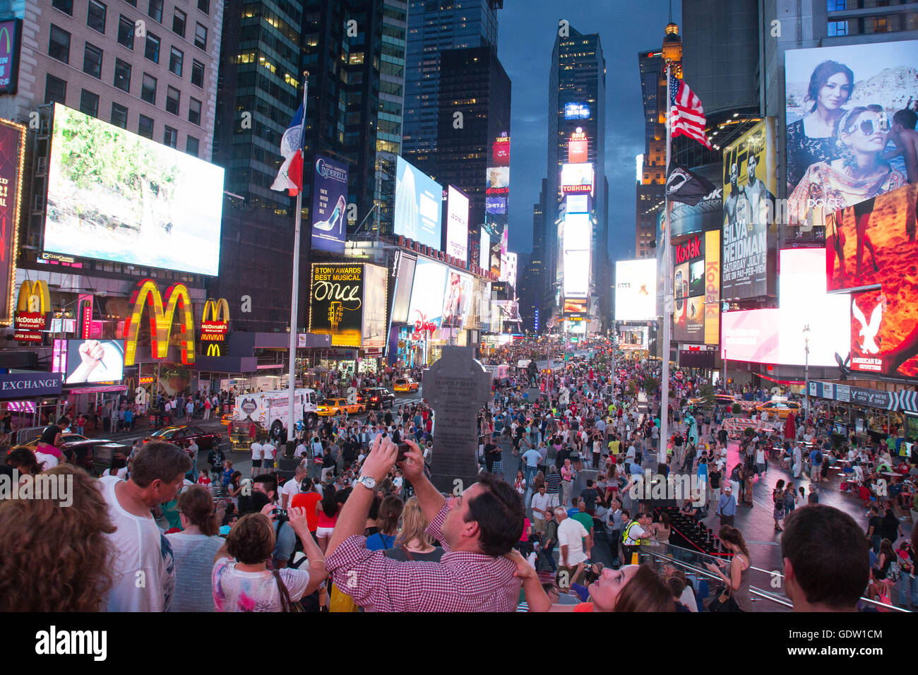 Times square tourists sitting hi-res stock photography and images - Alamy
