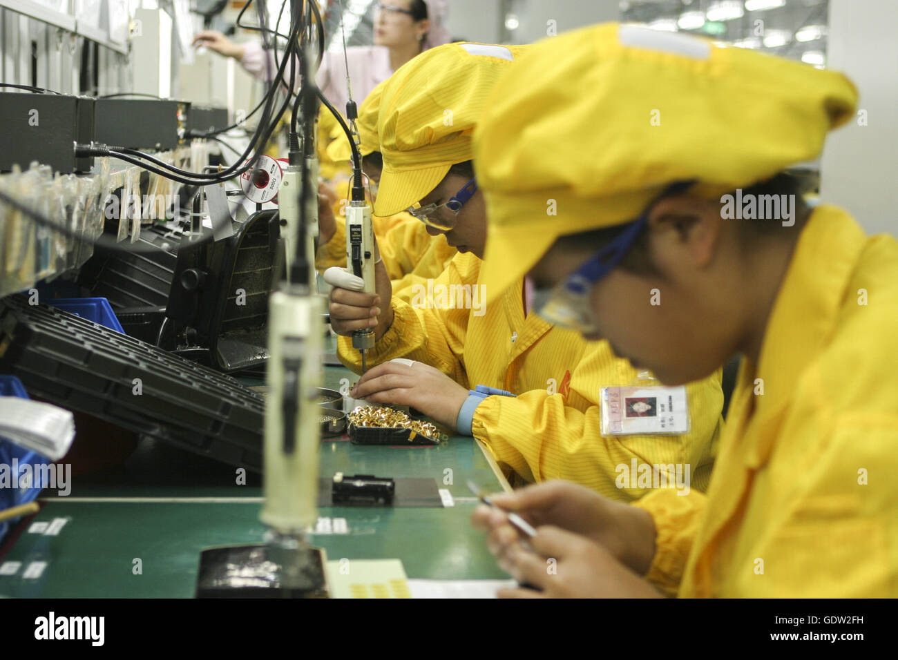 Factory workers assemble Kodak digital camera on a production line in ...