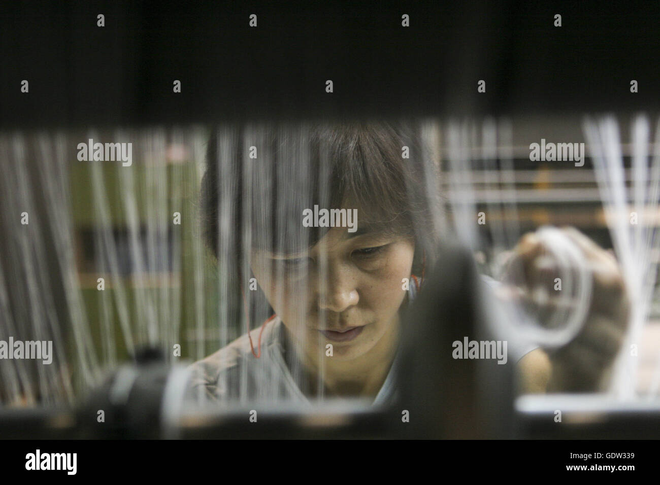 Factory workers handle yarn on a knitting machine December 10 Stock ...
