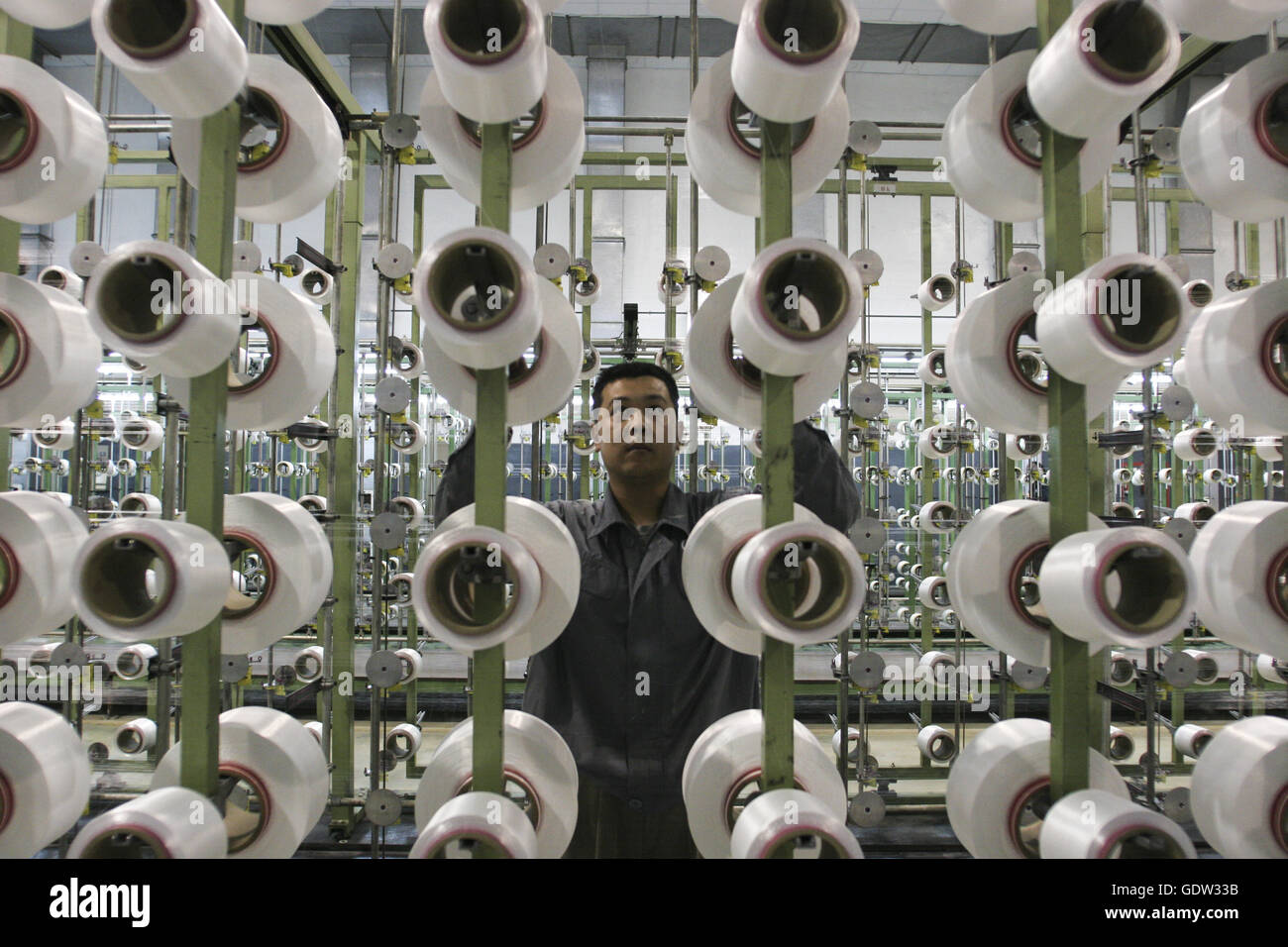 Factory workers handle yarn on a knitting machine december 10 hi-res ...