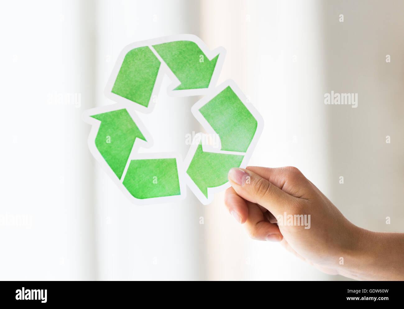 close up of hand holding green recycle symbol Stock Photo - Alamy