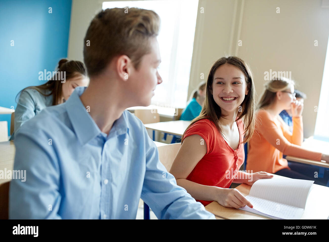 group of happy students talking at school break Stock Photo - Alamy