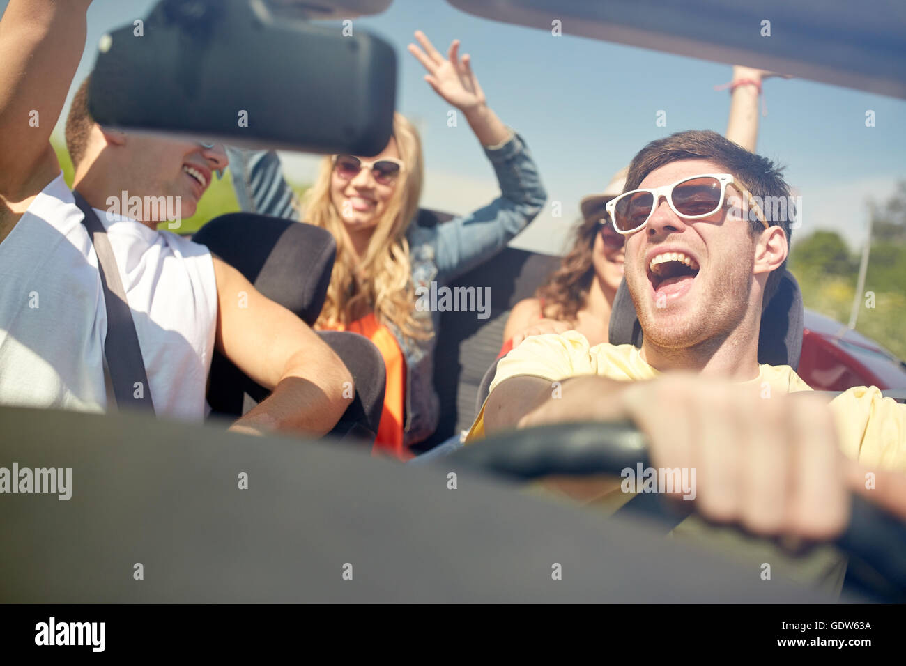 happy friends driving in cabriolet car Stock Photo - Alamy