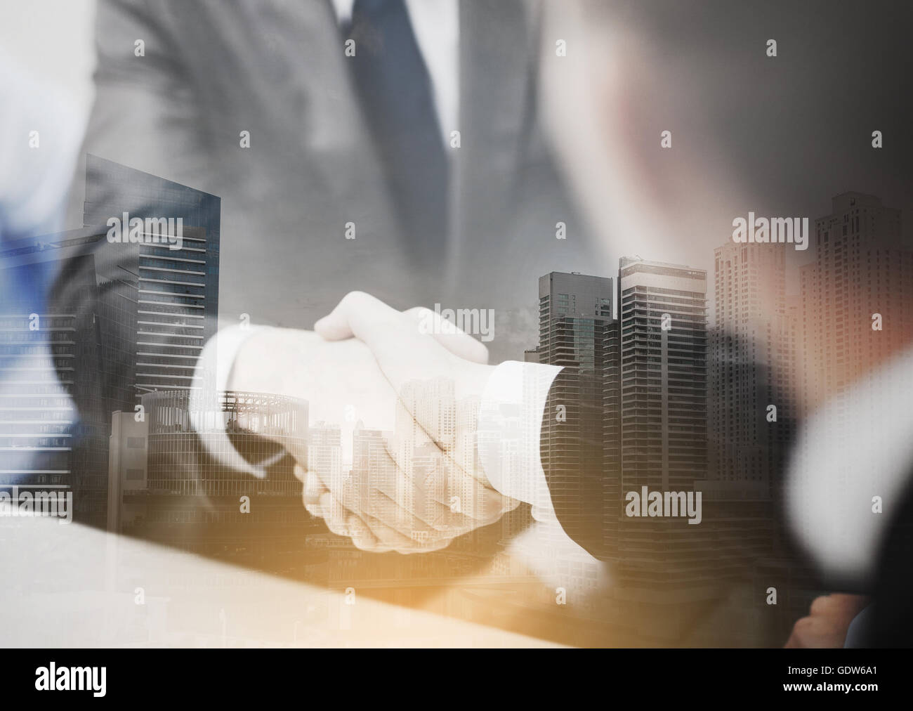two businessmen shaking hands in office Stock Photo - Alamy