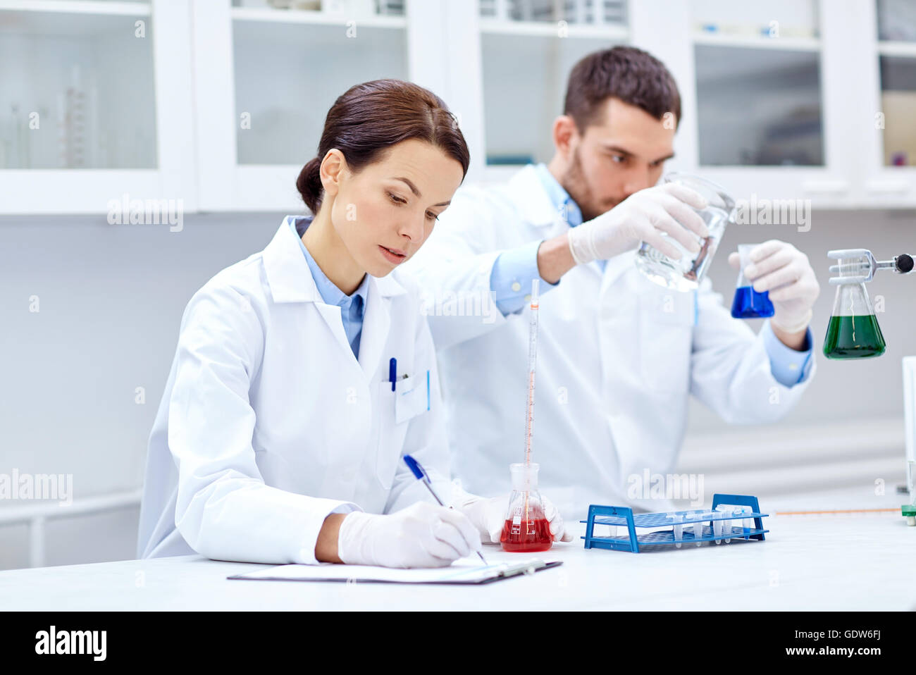 young scientists making test or research in lab Stock Photo - Alamy