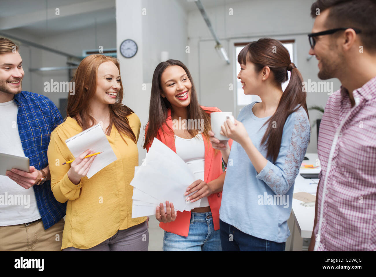 creative team on coffee break talking at office Stock Photo - Alamy