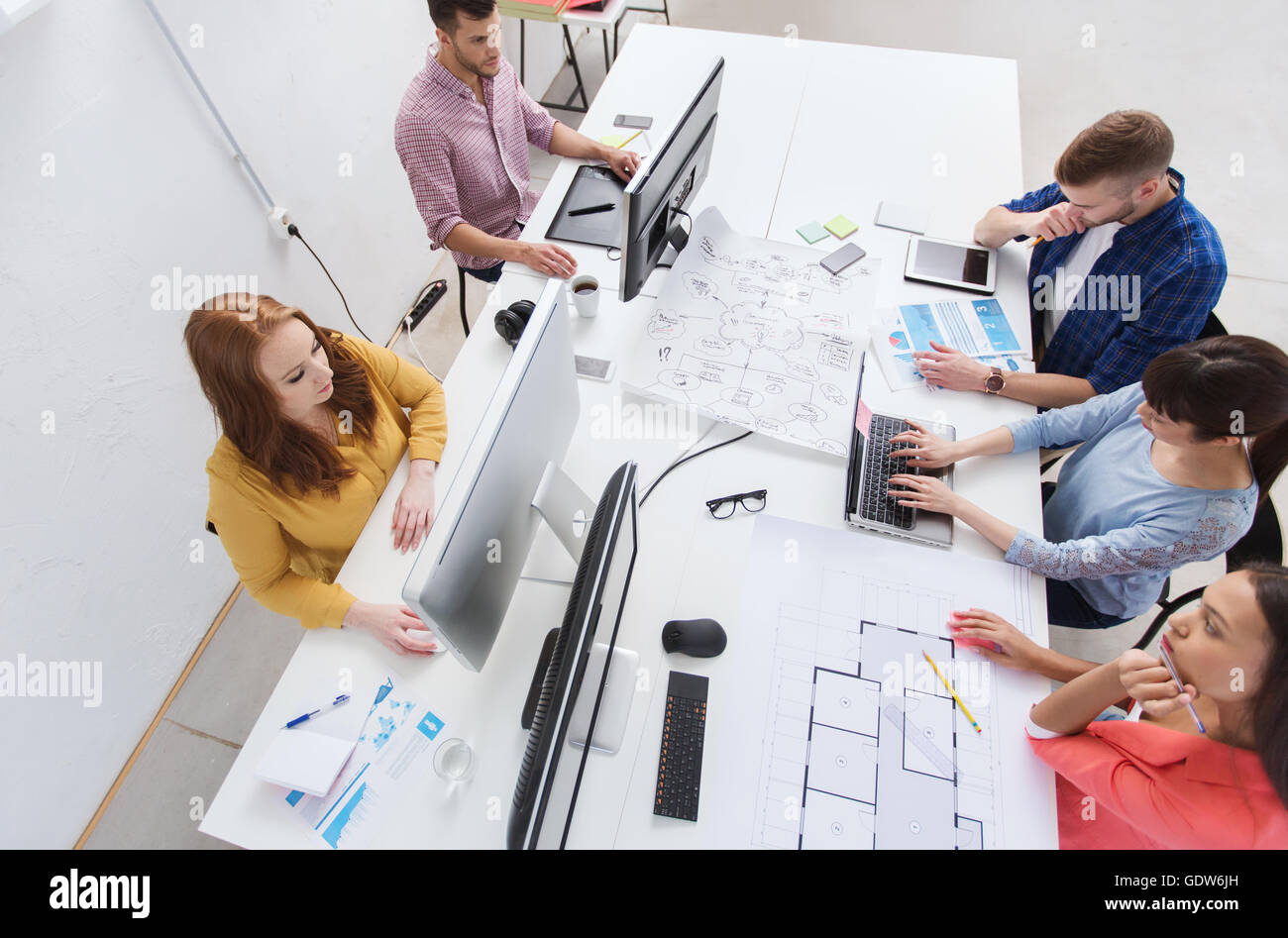 creative team with computers, blueprint at office Stock Photo - Alamy