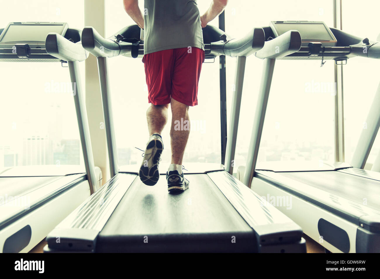 close up of male legs running on treadmill in gym Stock Photo - Alamy
