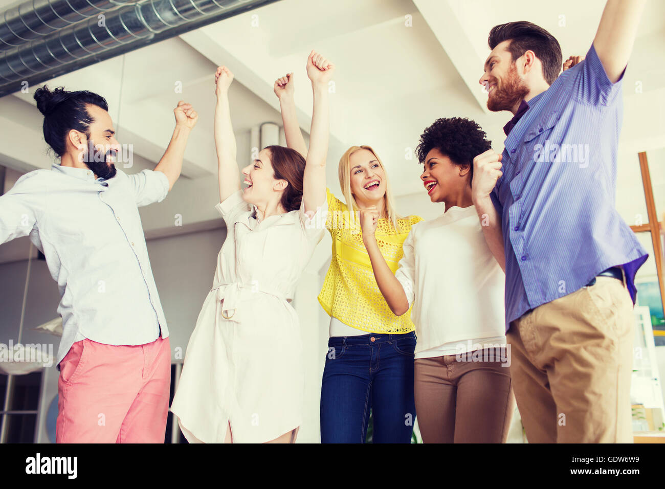 happy creative team in office Stock Photo - Alamy