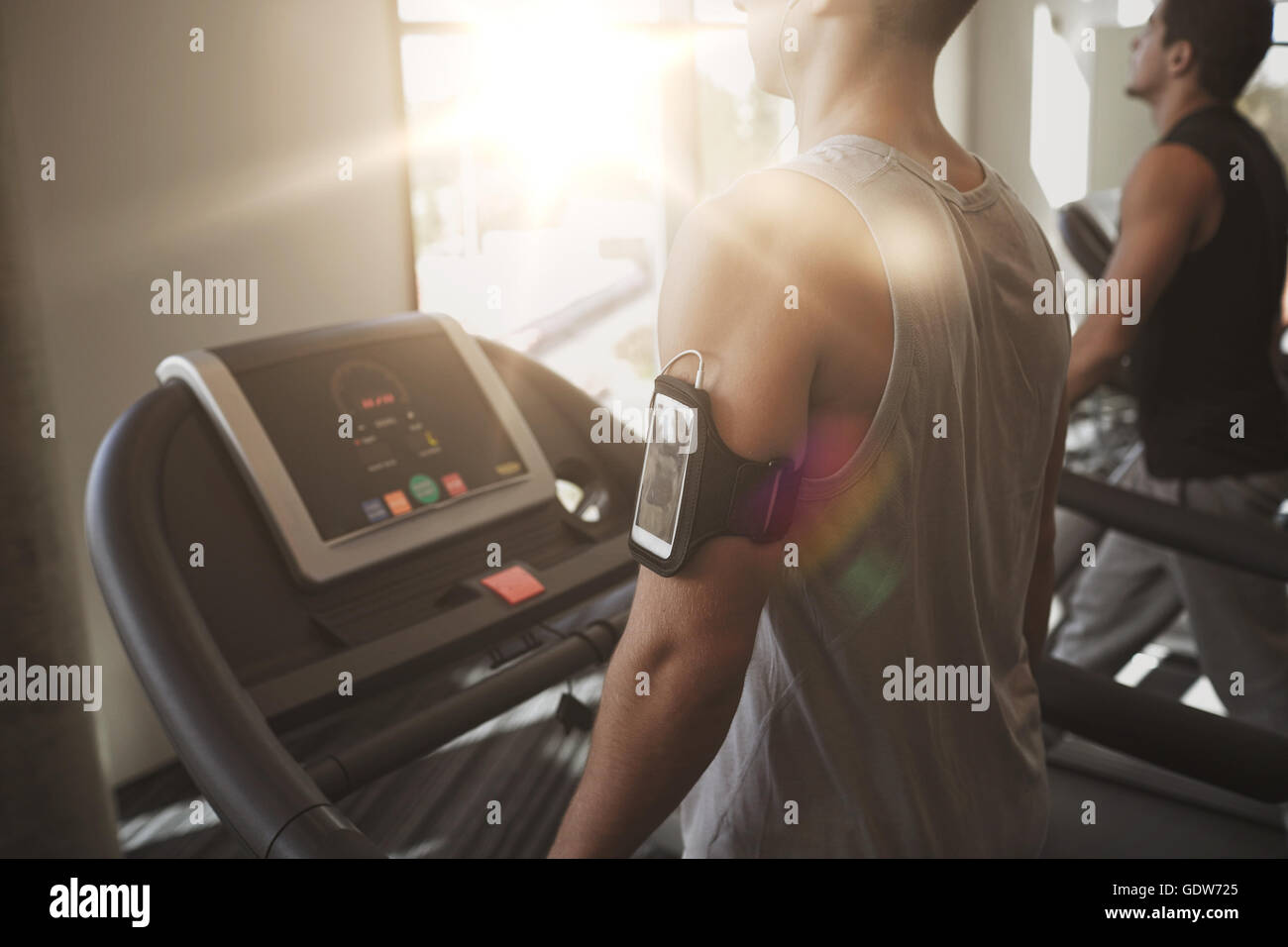 smiling men exercising on treadmill in gym Stock Photo - Alamy