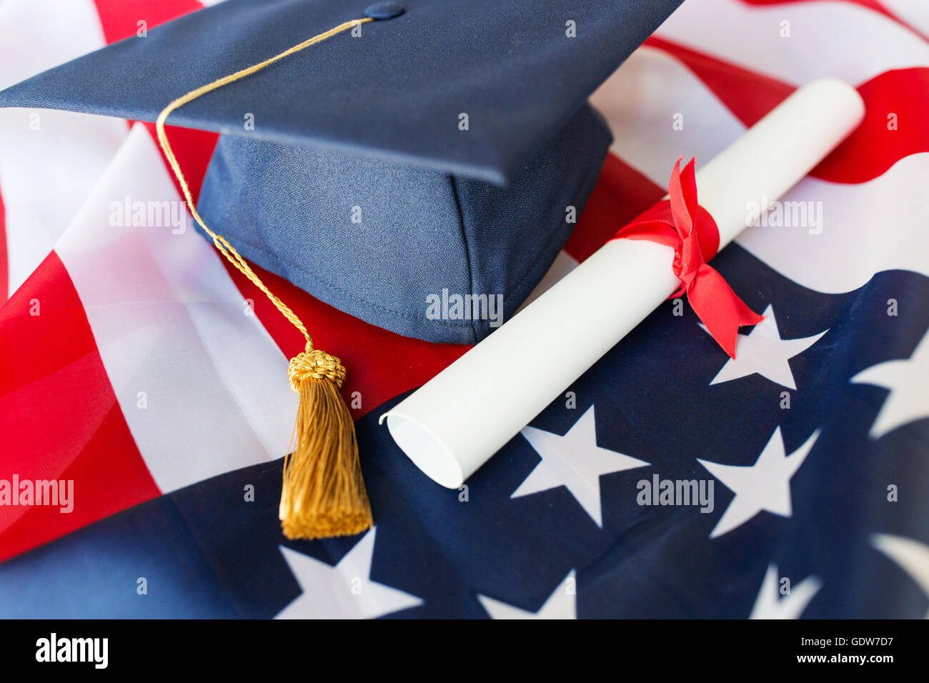 bachelor hat and diploma on american flag Stock Photo - Alamy