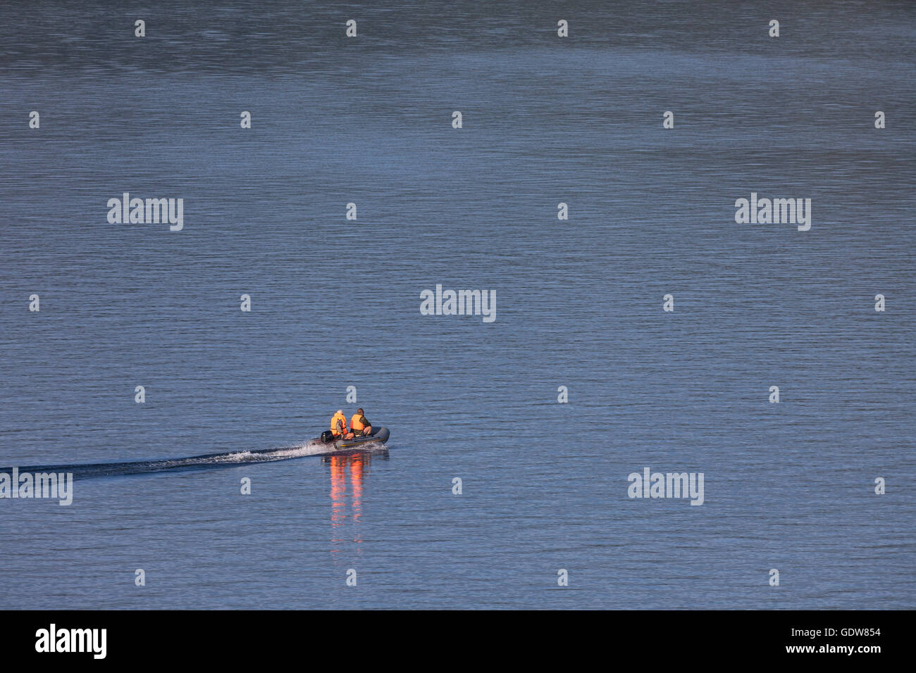 Two fisher in a power boat Stock Photo - Alamy
