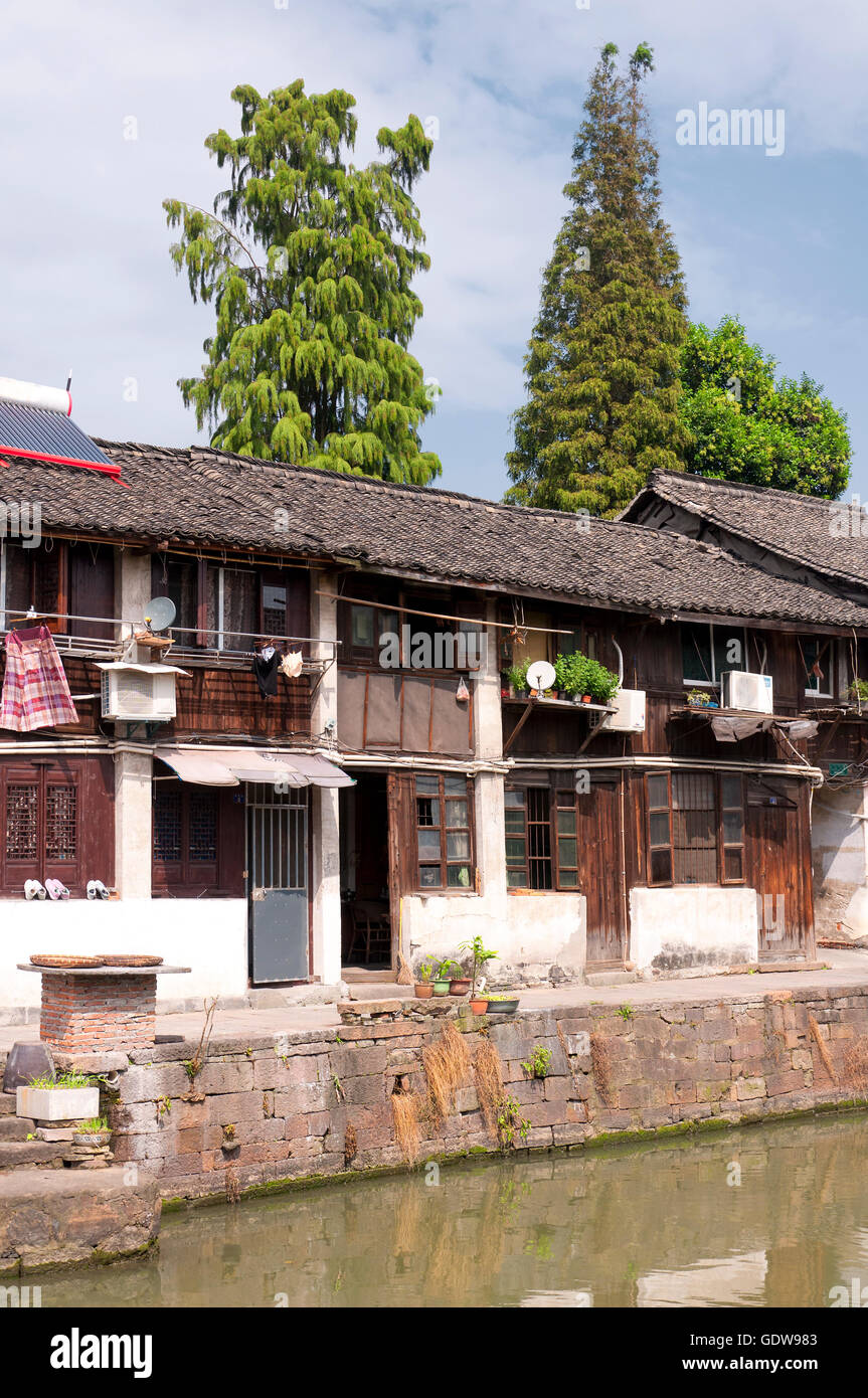 Chinese style weathered homes lining the water canals of Xinshi Town in ...