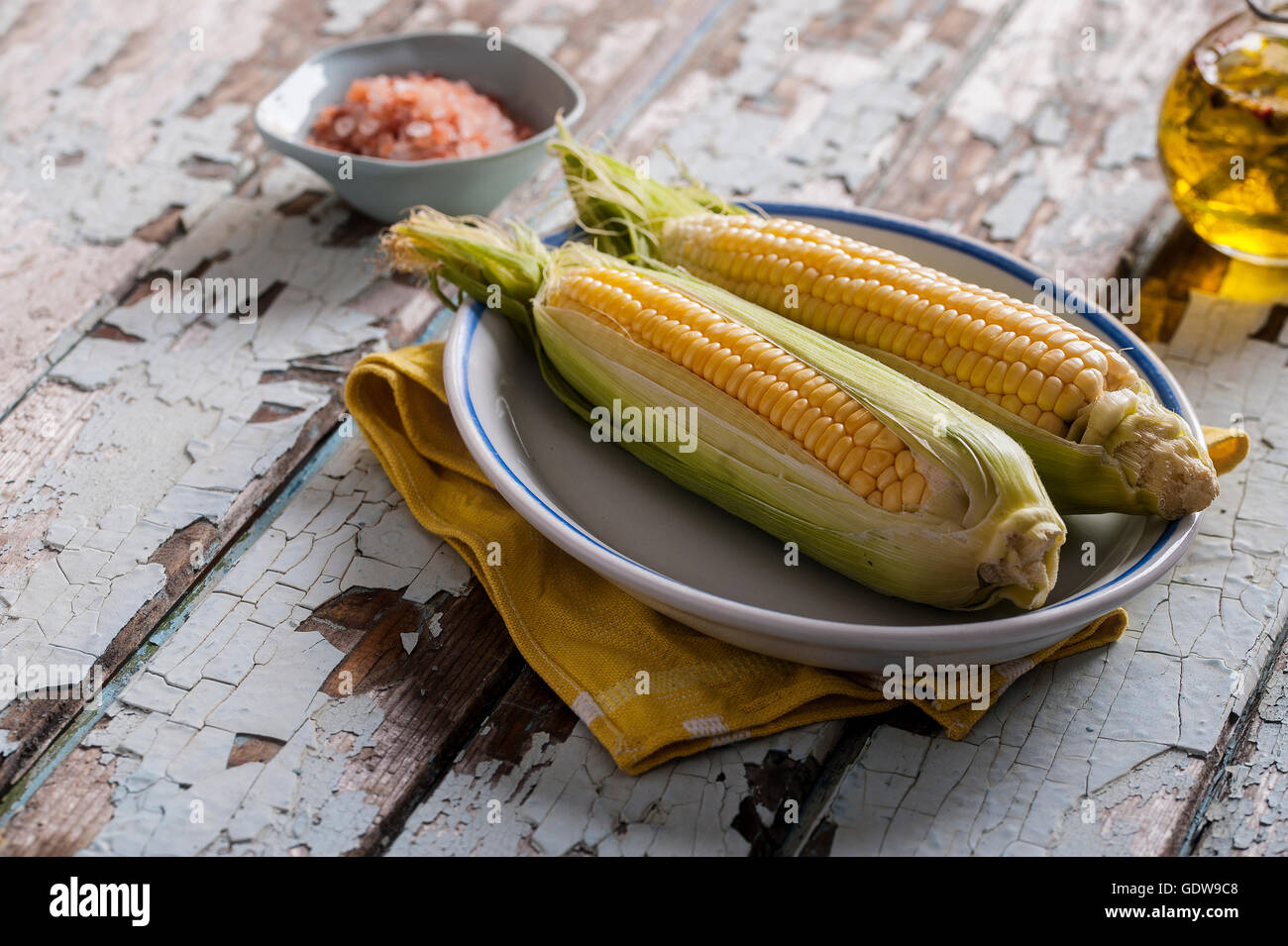Raw corn on a wood table Stock Photo - Alamy