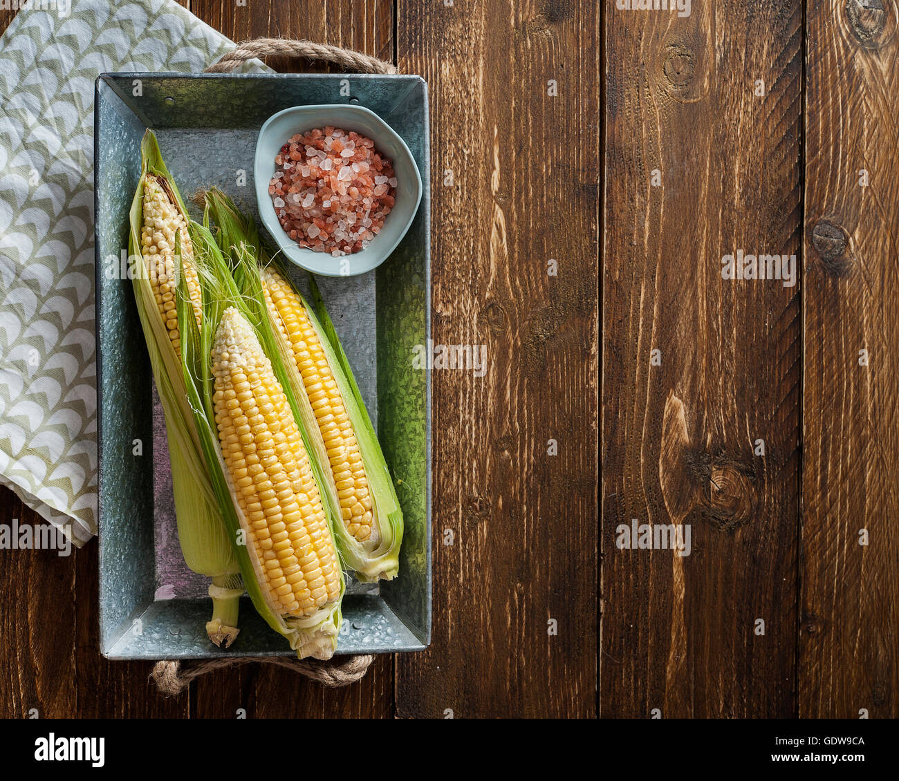 Raw corn on a wood table Stock Photo - Alamy