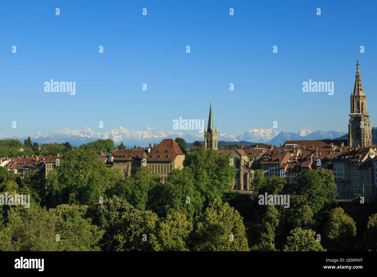 A photograph of the Bern's old town with the alps in the background ...