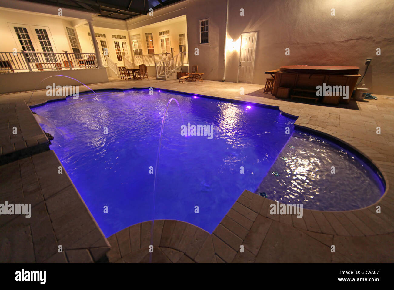 A Swimming Pool lit up a night Stock Photo - Alamy