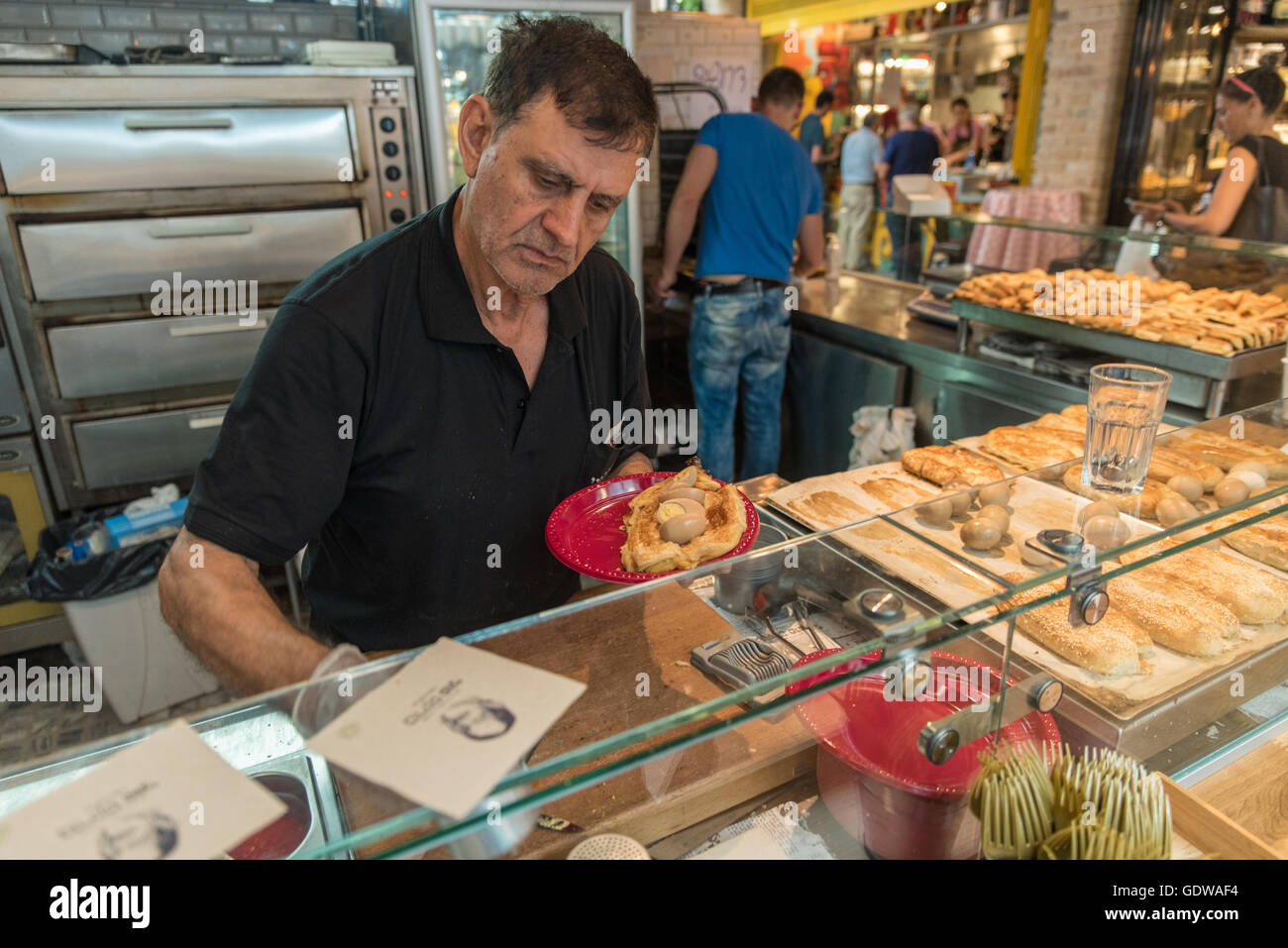 Making and serving Borekas at "Puni's Borekas" in Sarona Market, Israel ...