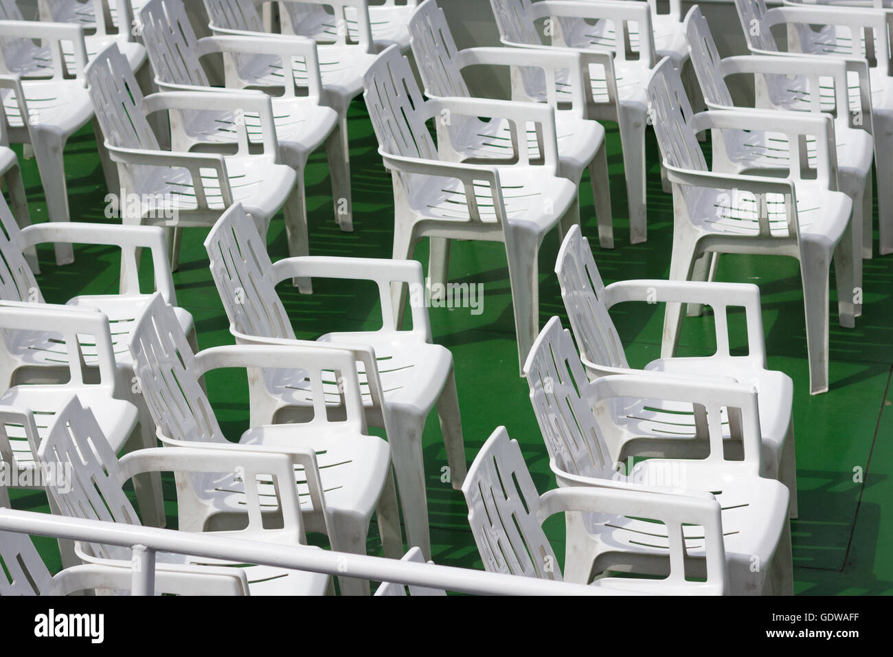 many white empty plastic chairs in rows Stock Photo - Alamy