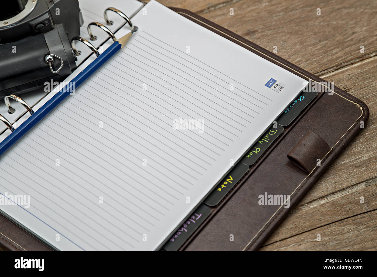 Diary with Retro Camera on a wooden table Stock Photo - Alamy