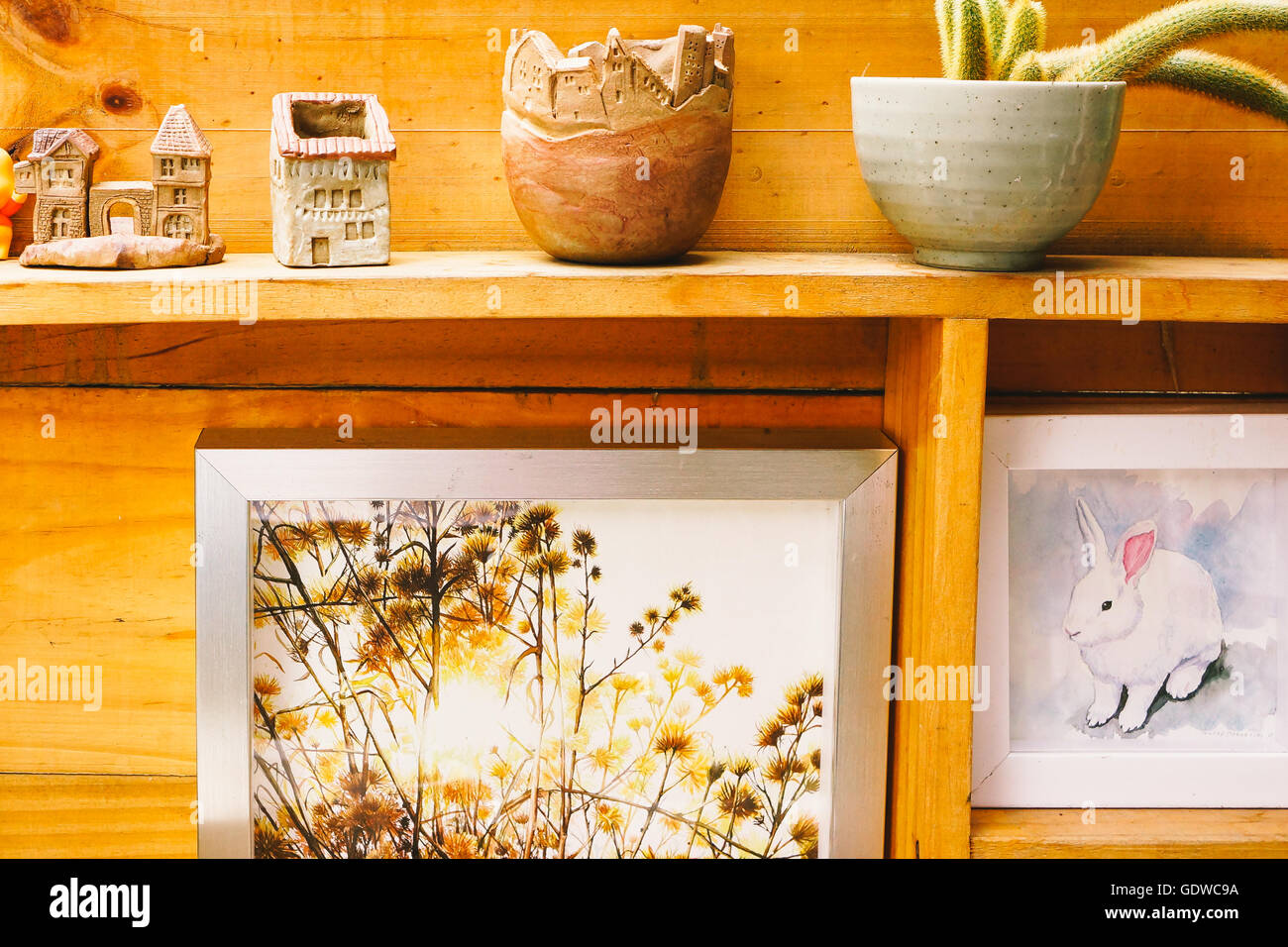 Small clay house model in woodshelf interior decorate Stock Photo - Alamy