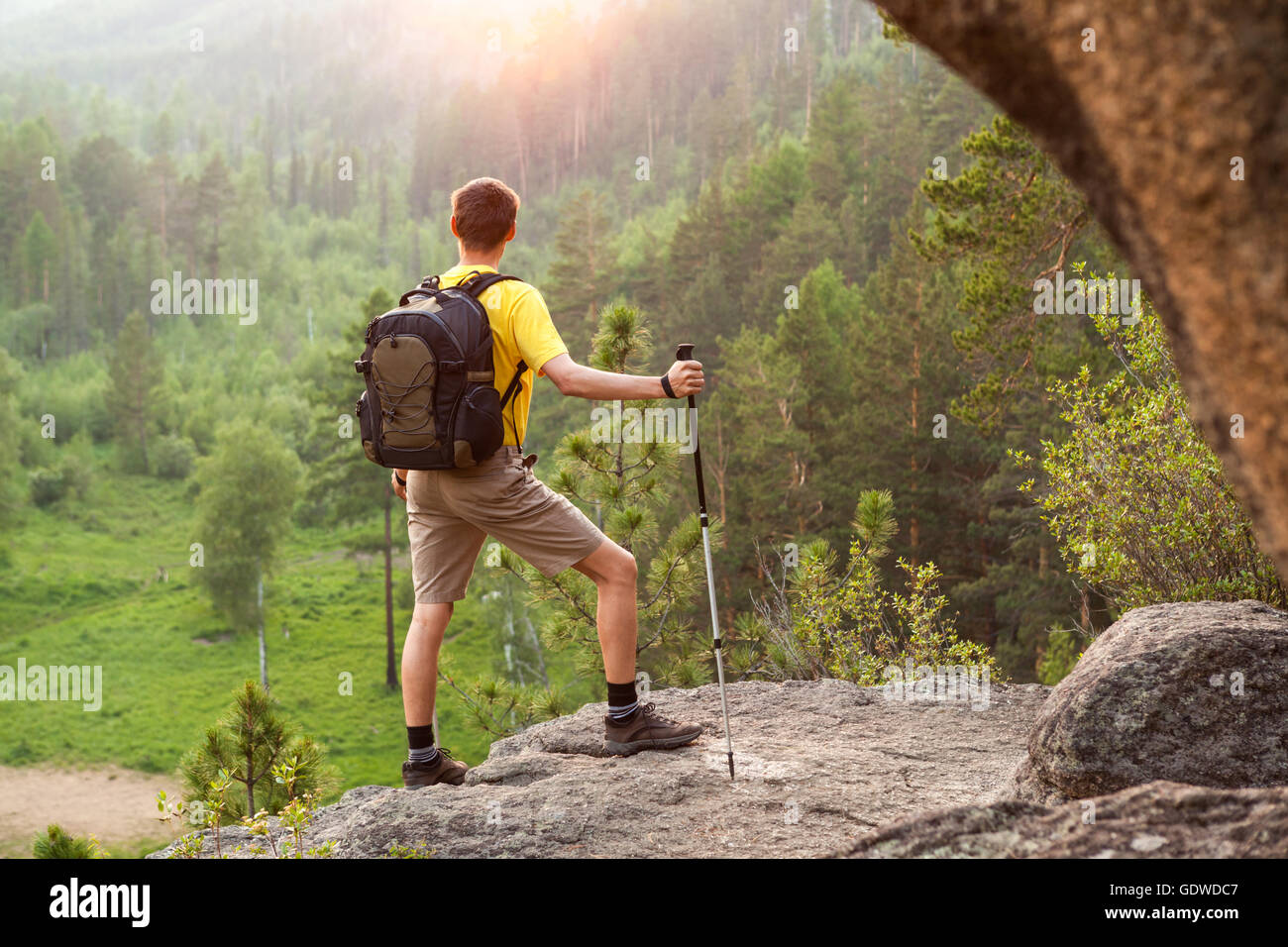 Backpacker go up mountain Stock Photo - Alamy