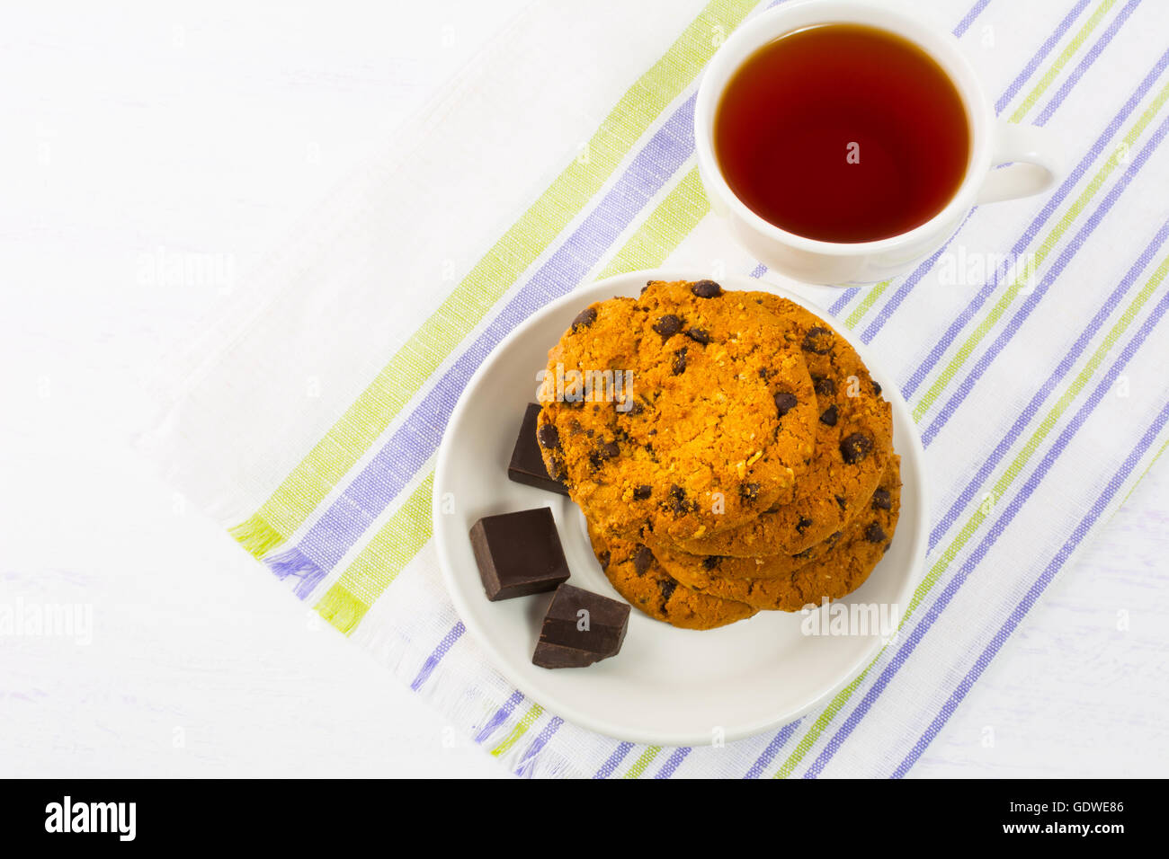 Cup of tea with chocolate chip cookies and dark chocolate. Breakfast ...