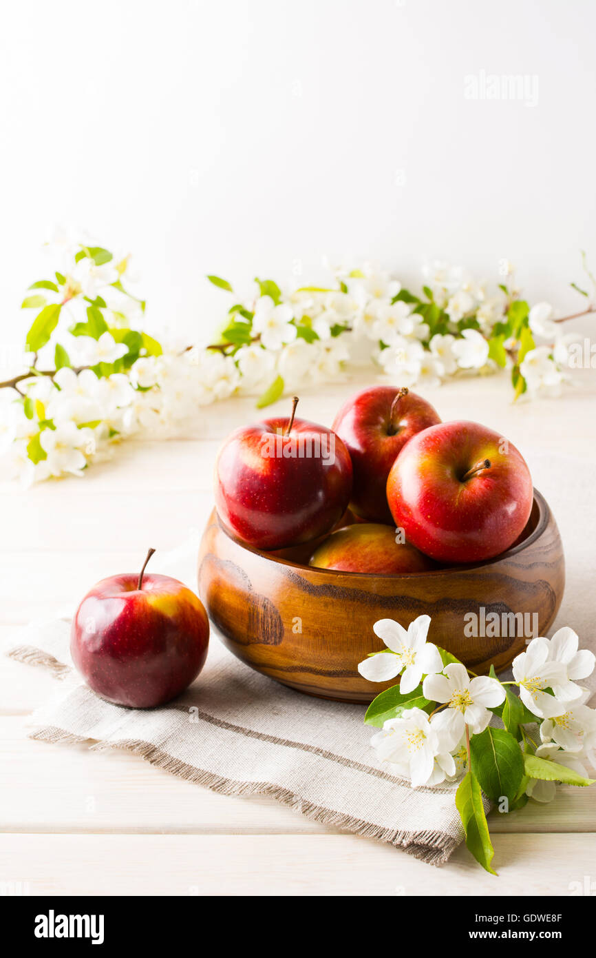 Fresh apples in the wooden bowl vertical. Ripe fruits as healthy eating ...