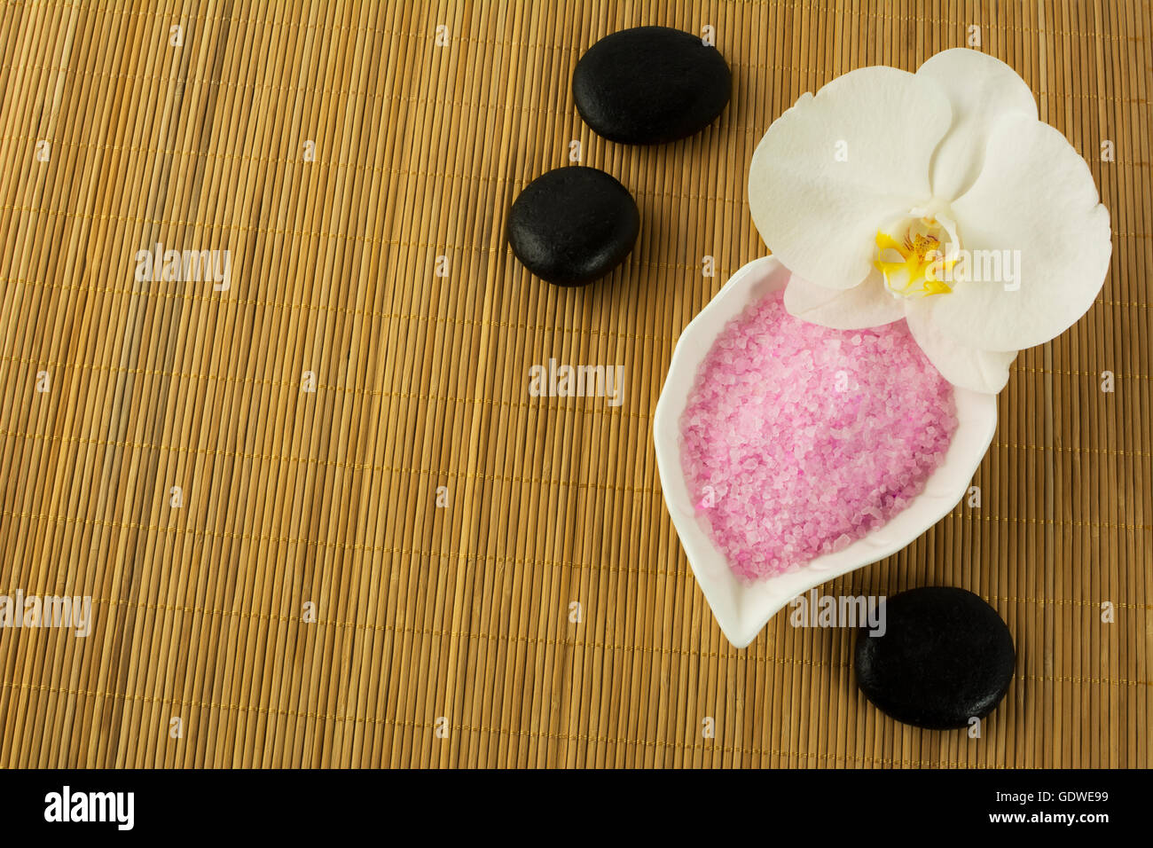 Spa concept with pink sea salt and spa stones. Spa treatment concept ...