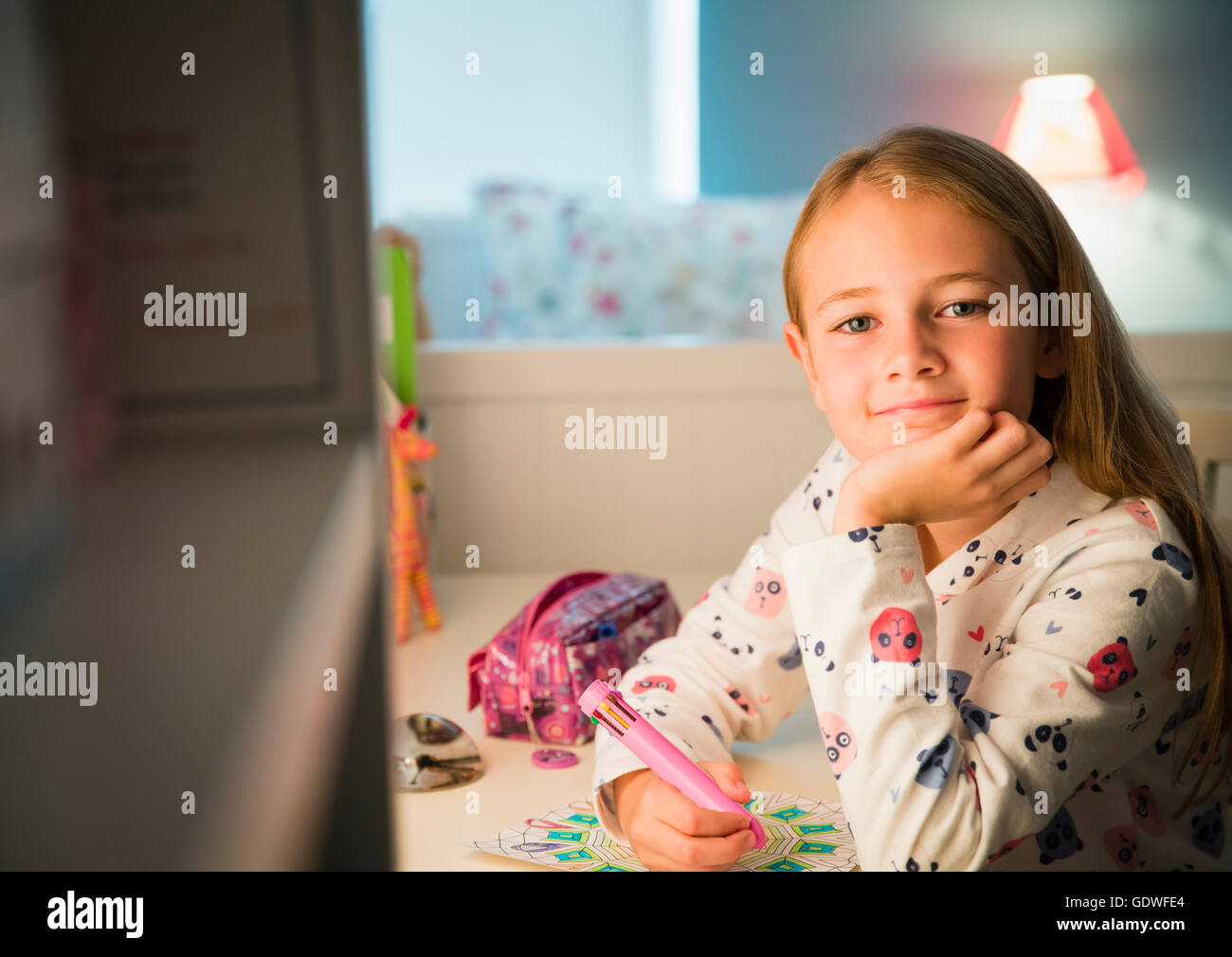 Portrait smiling girl coloring in bedroom Stock Photo - Alamy