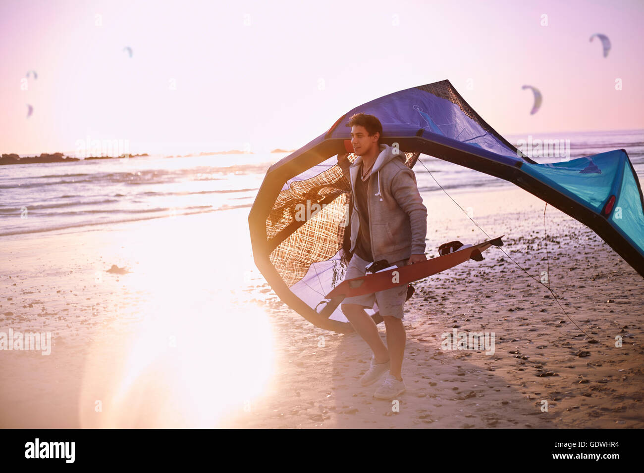 Young man kitesurfing sunset hi-res stock photography and images - Alamy